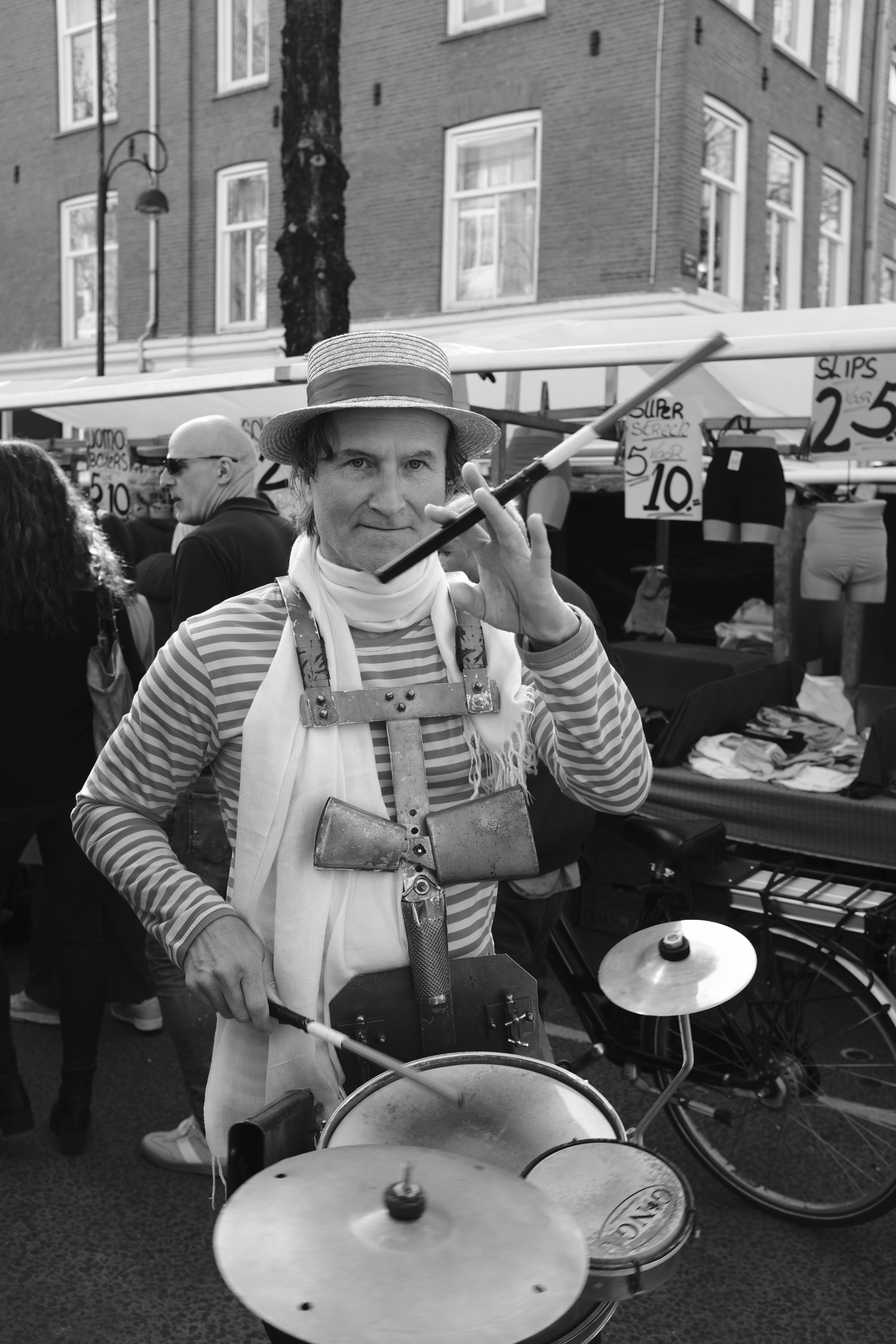 Street Serenade: The Drummer in Stripes and Straw Hat