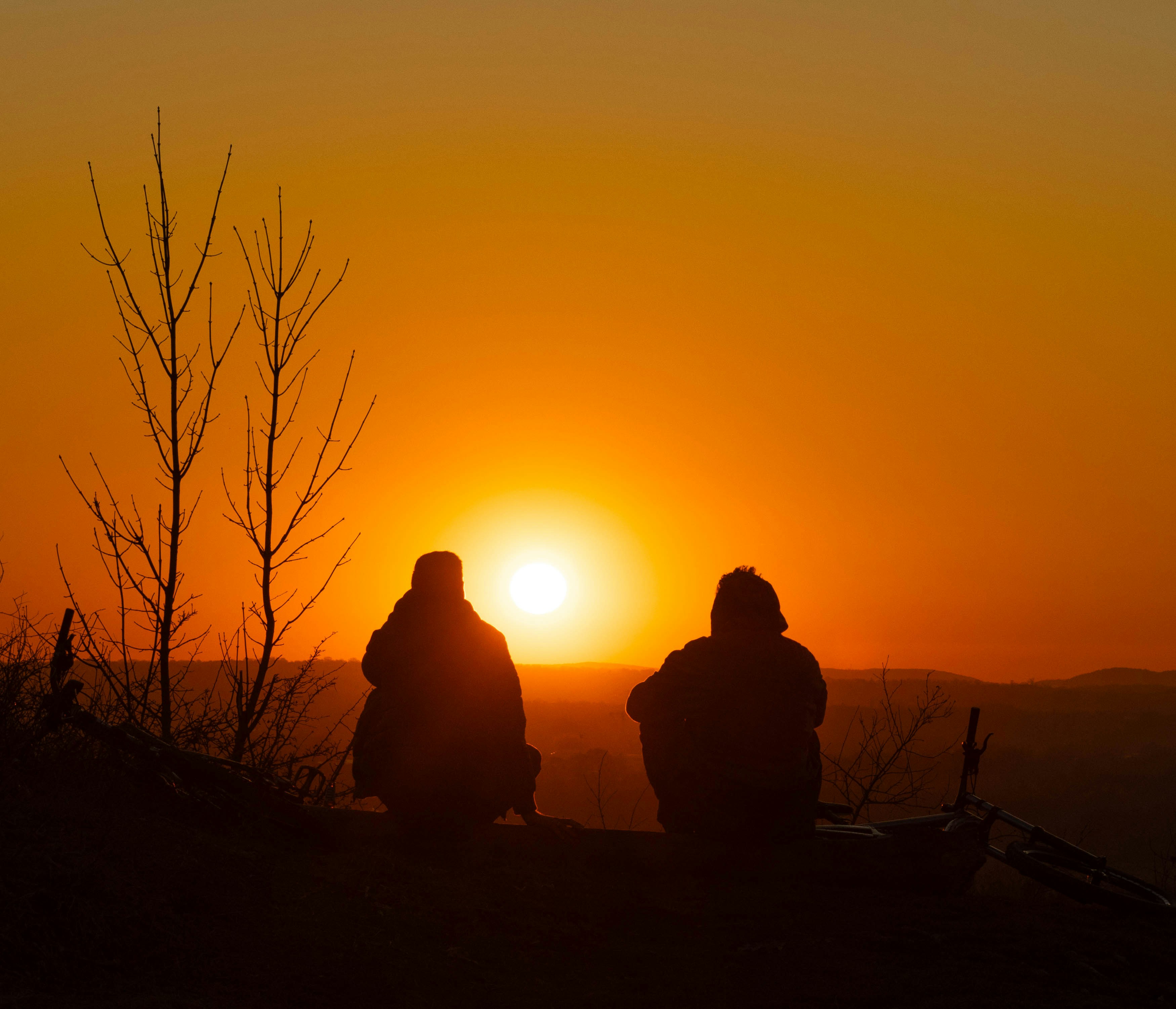 Two Silhouettes at Dusk: Quiet Conversation Under a Burning Horizon
