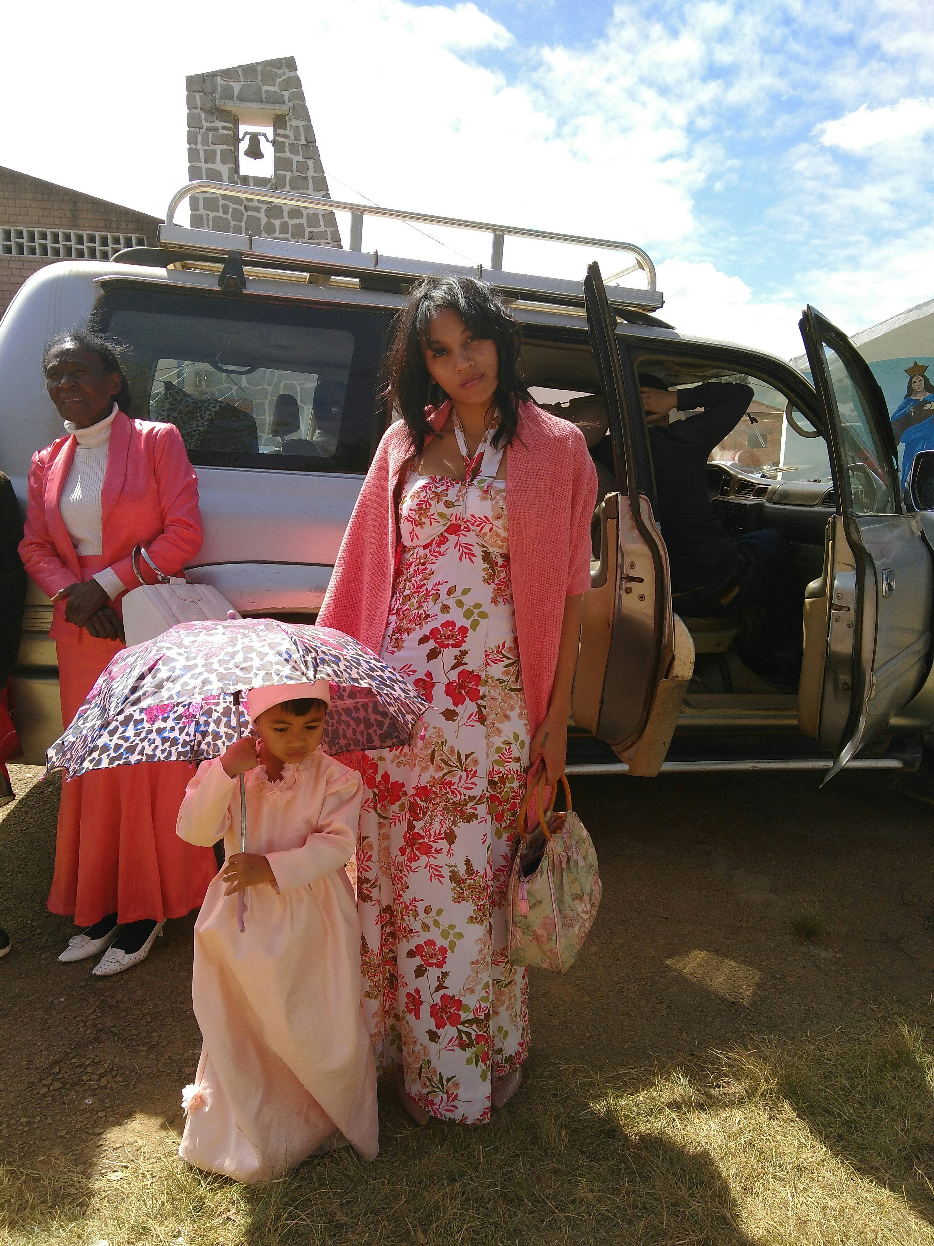 Family Moment at the Vehicle Doorstep in Sunny Grounds