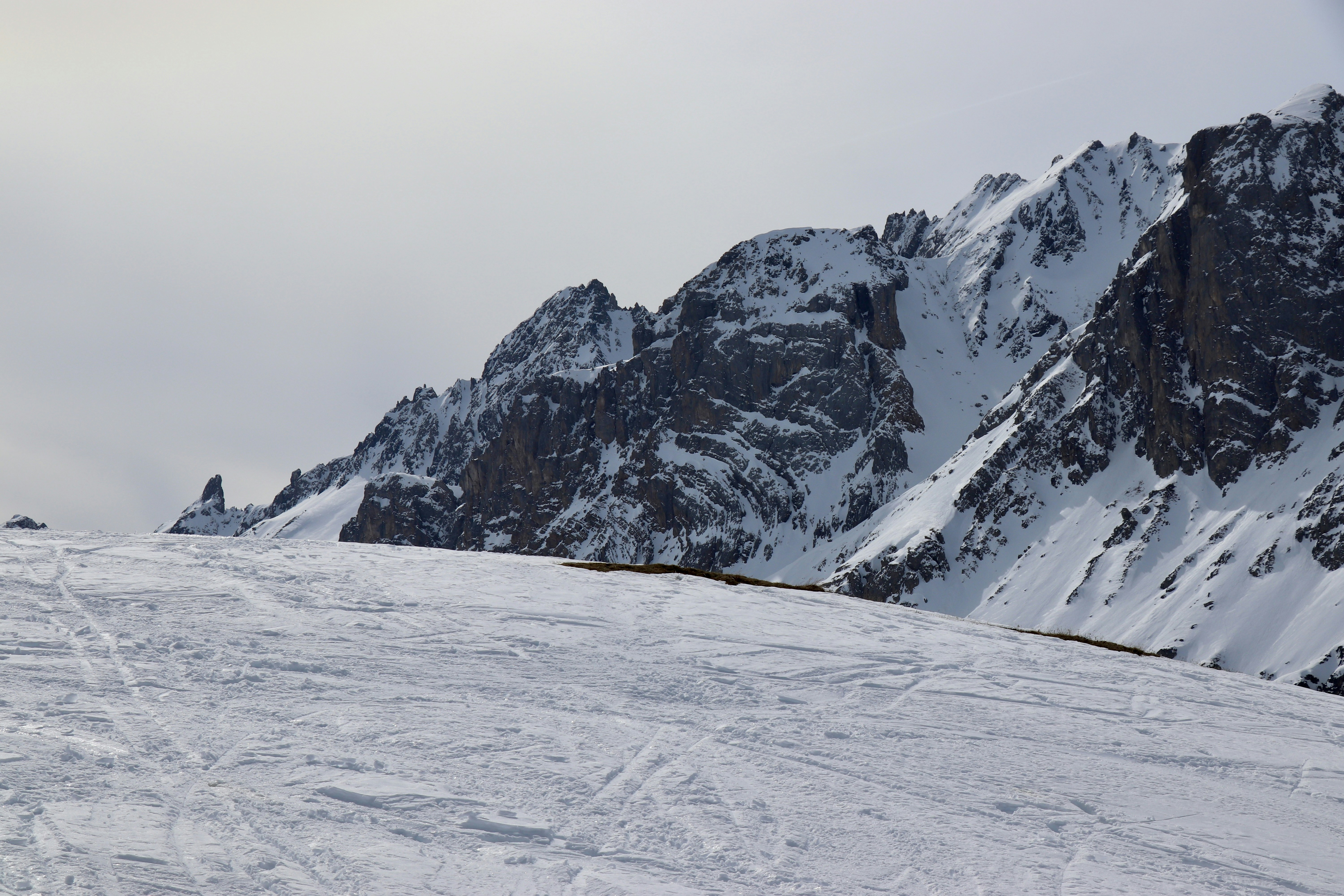 Snow-Scarred Ridge Under an Overcast Sky