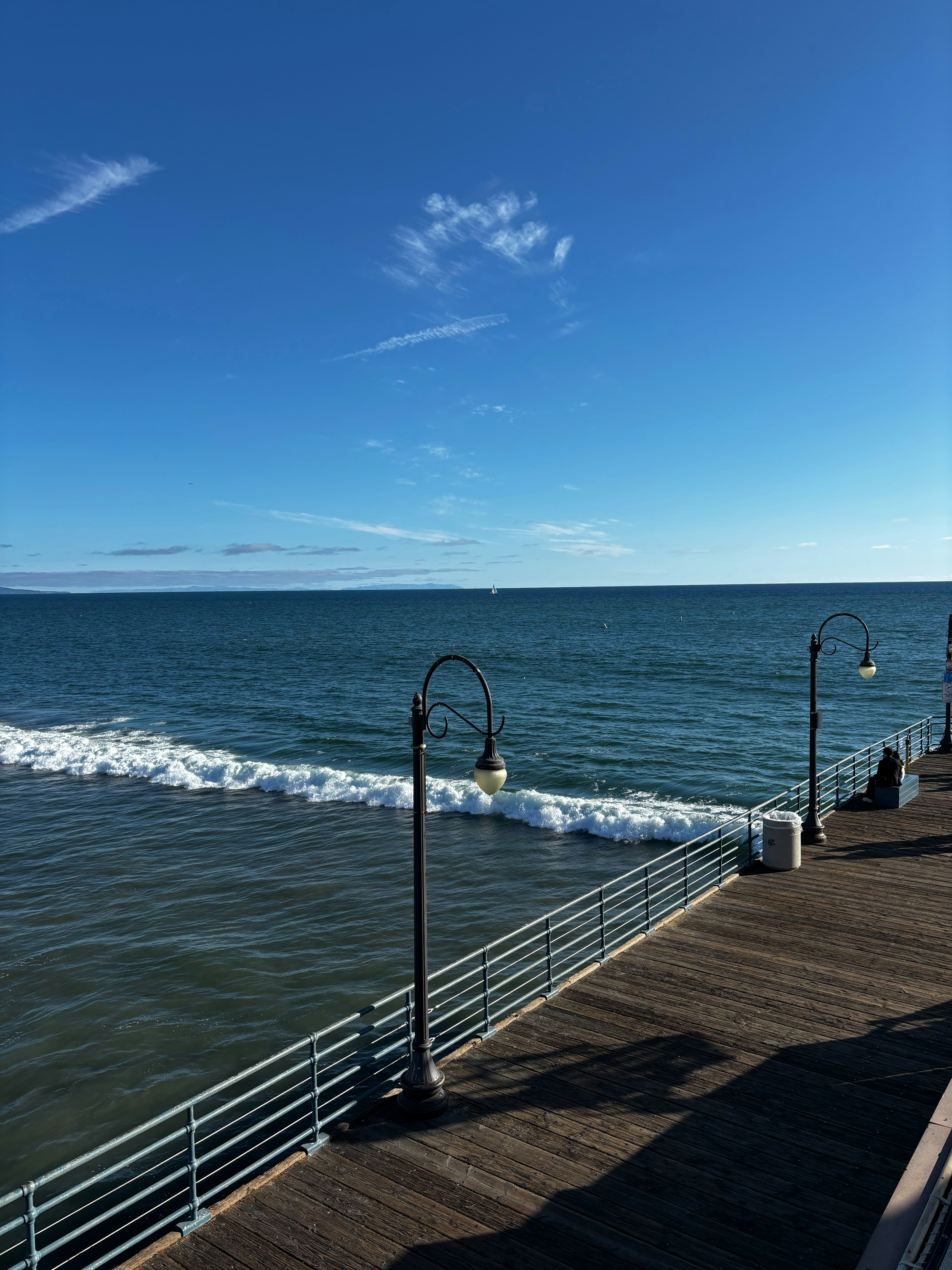 Pier Lanterns Over the Calm Horizon