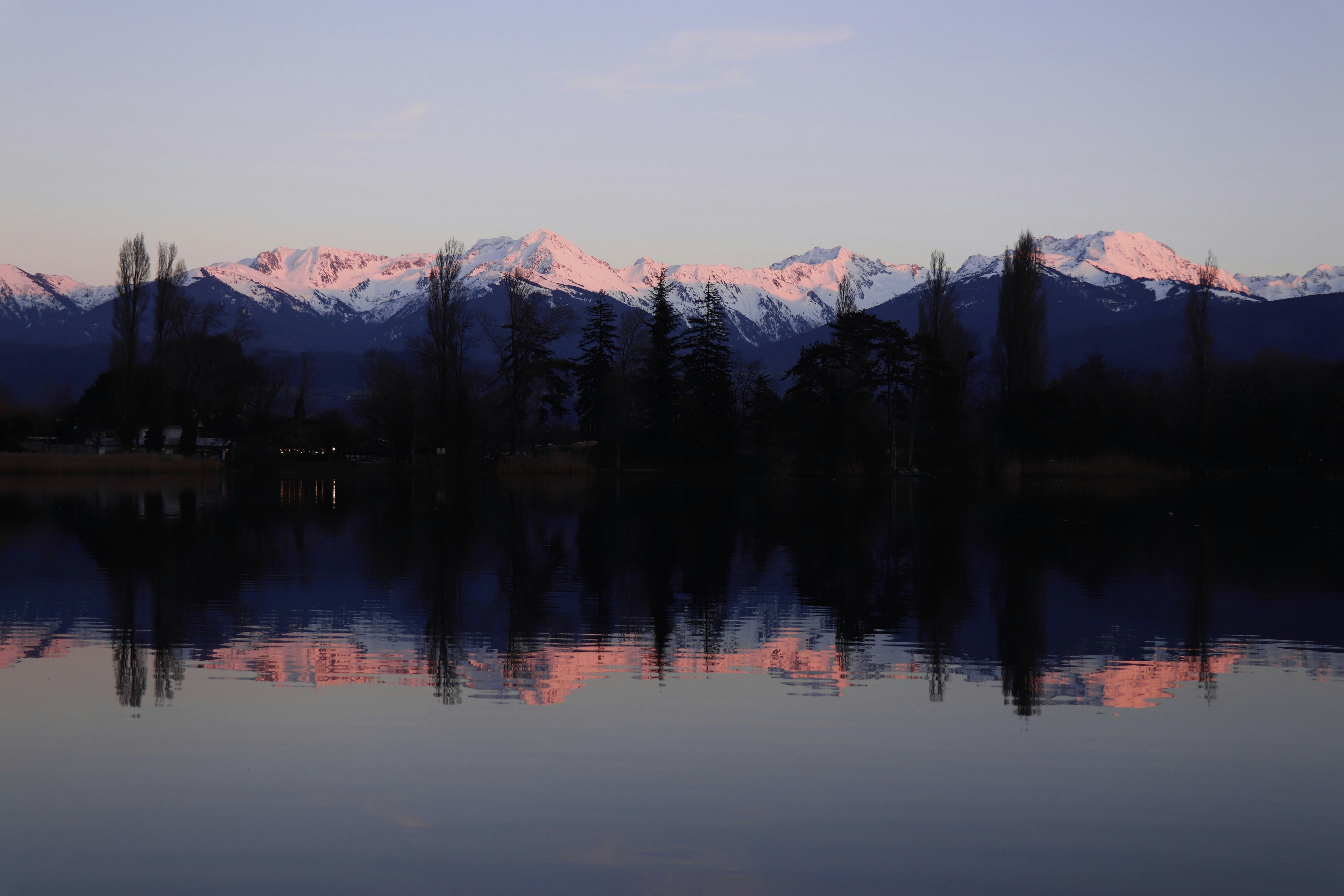 Dawn Crests: Snow-Capped Peaks Reflected on a Quiet Lake