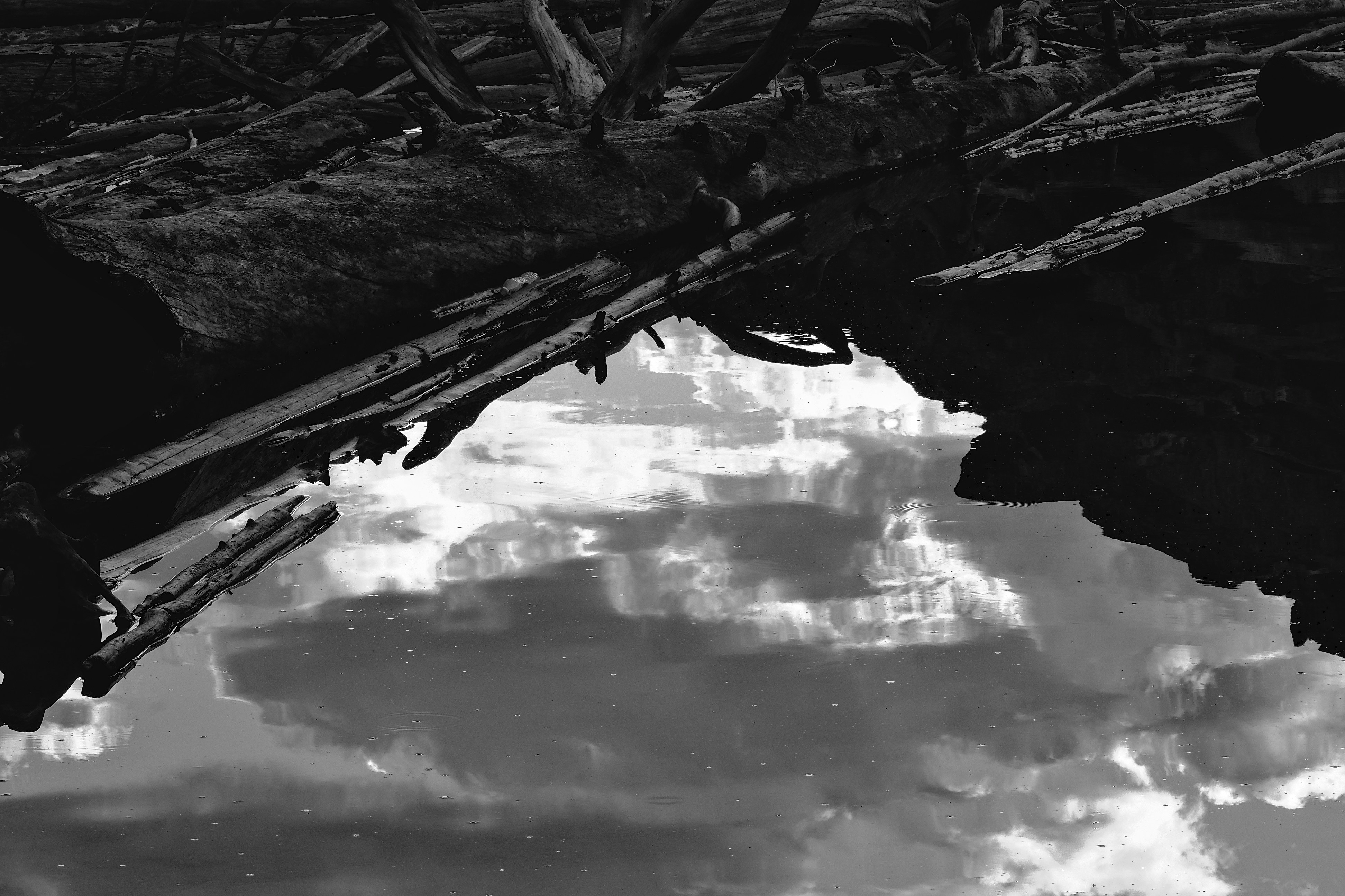 Echoes of Sky and Debris: A Quiet Photograph of Ruins Reflected