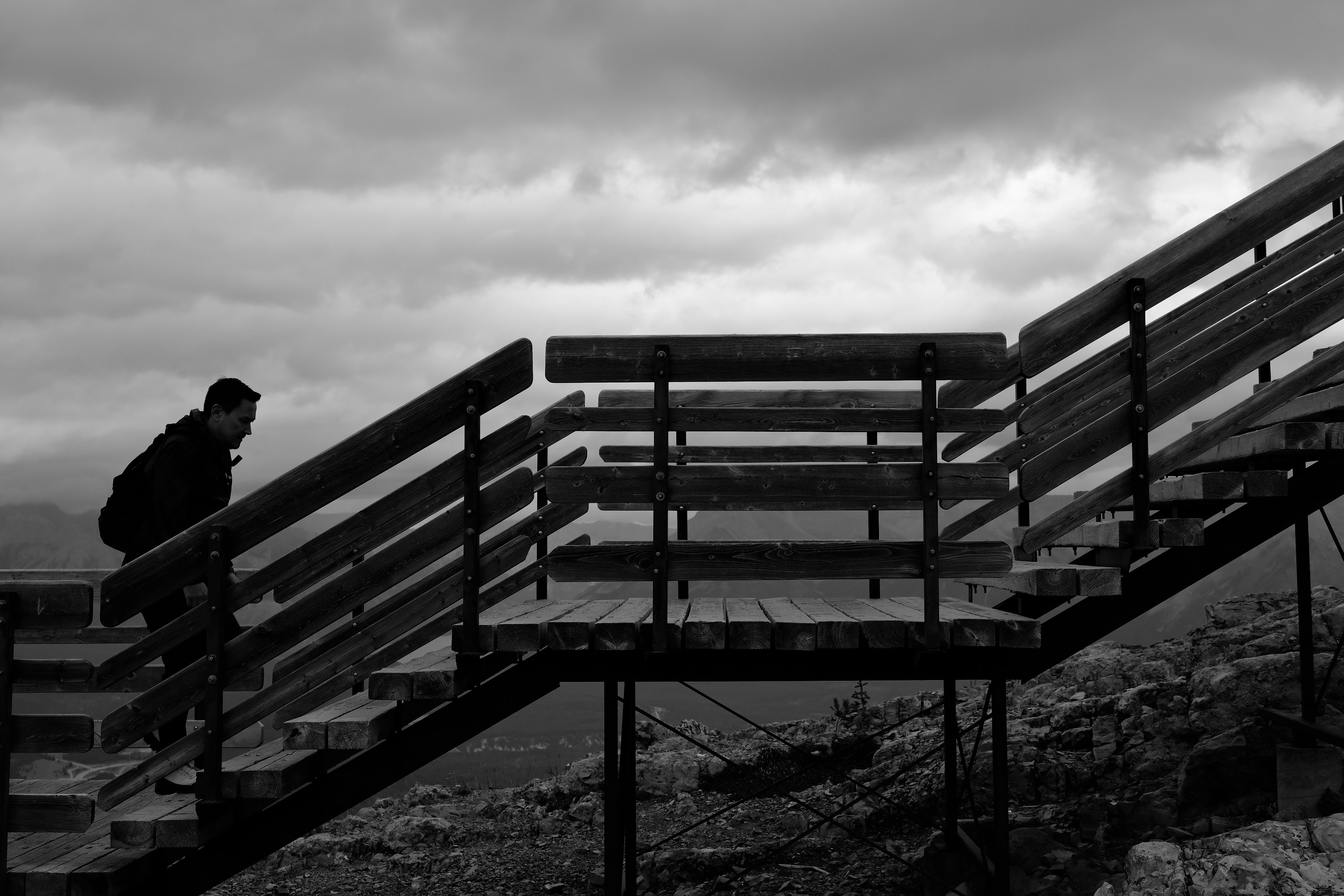 Silhouette on the Steps: A Quiet Ascent Towards Skyward Lines