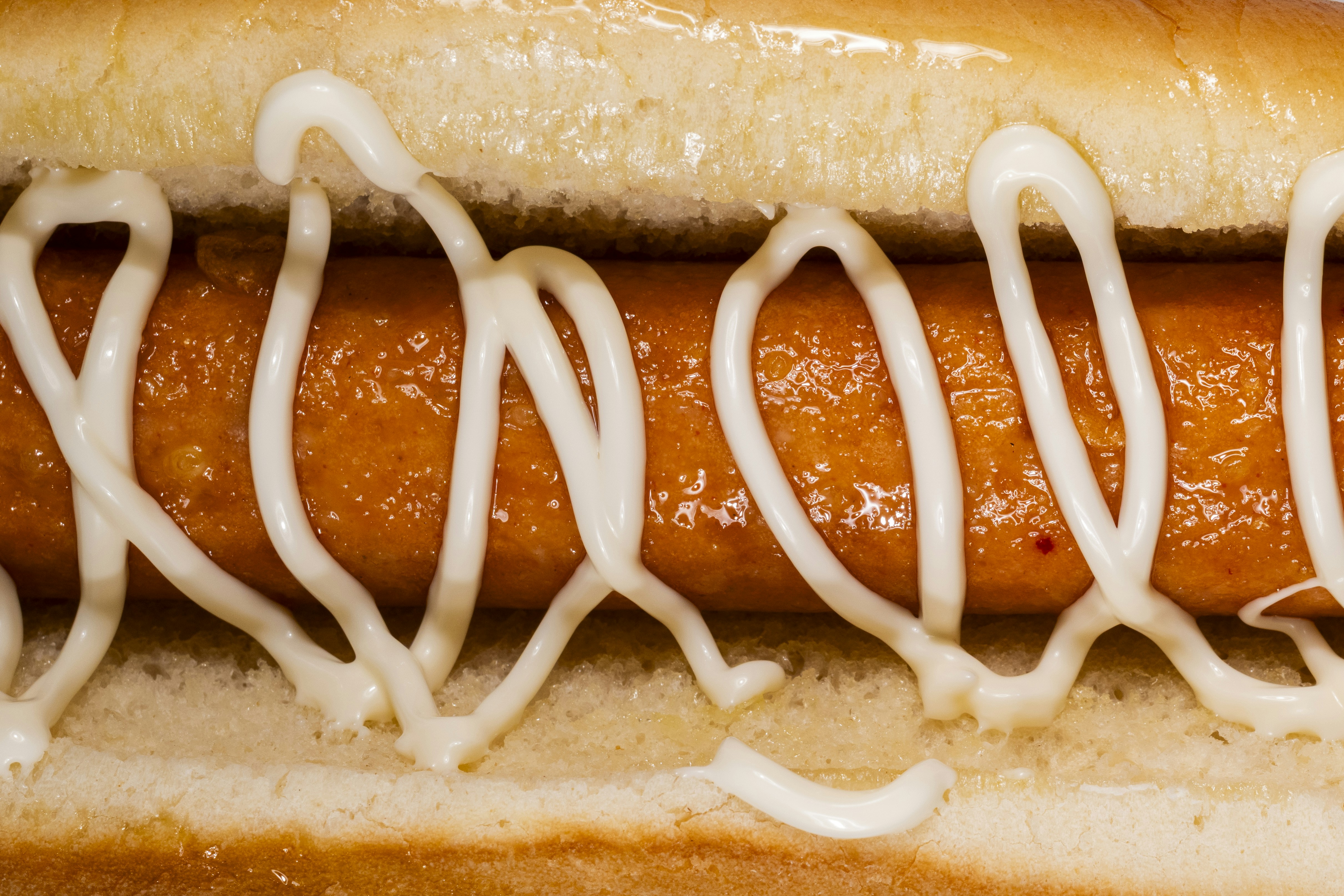 Detail of a Saucy Hot Dog Showered in White Zest