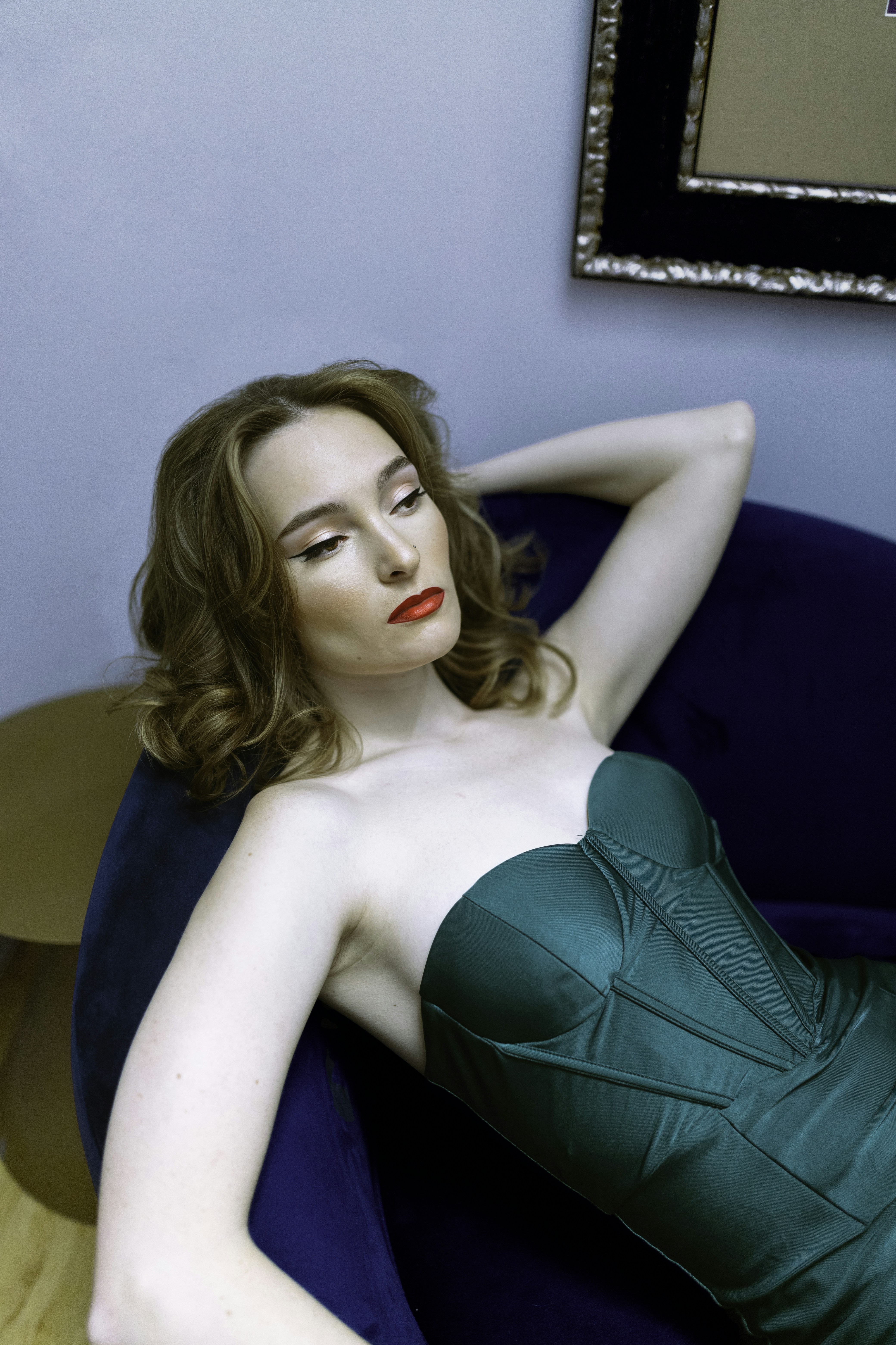 Velvet Green: A Charcoal-Red Study on a Sofa