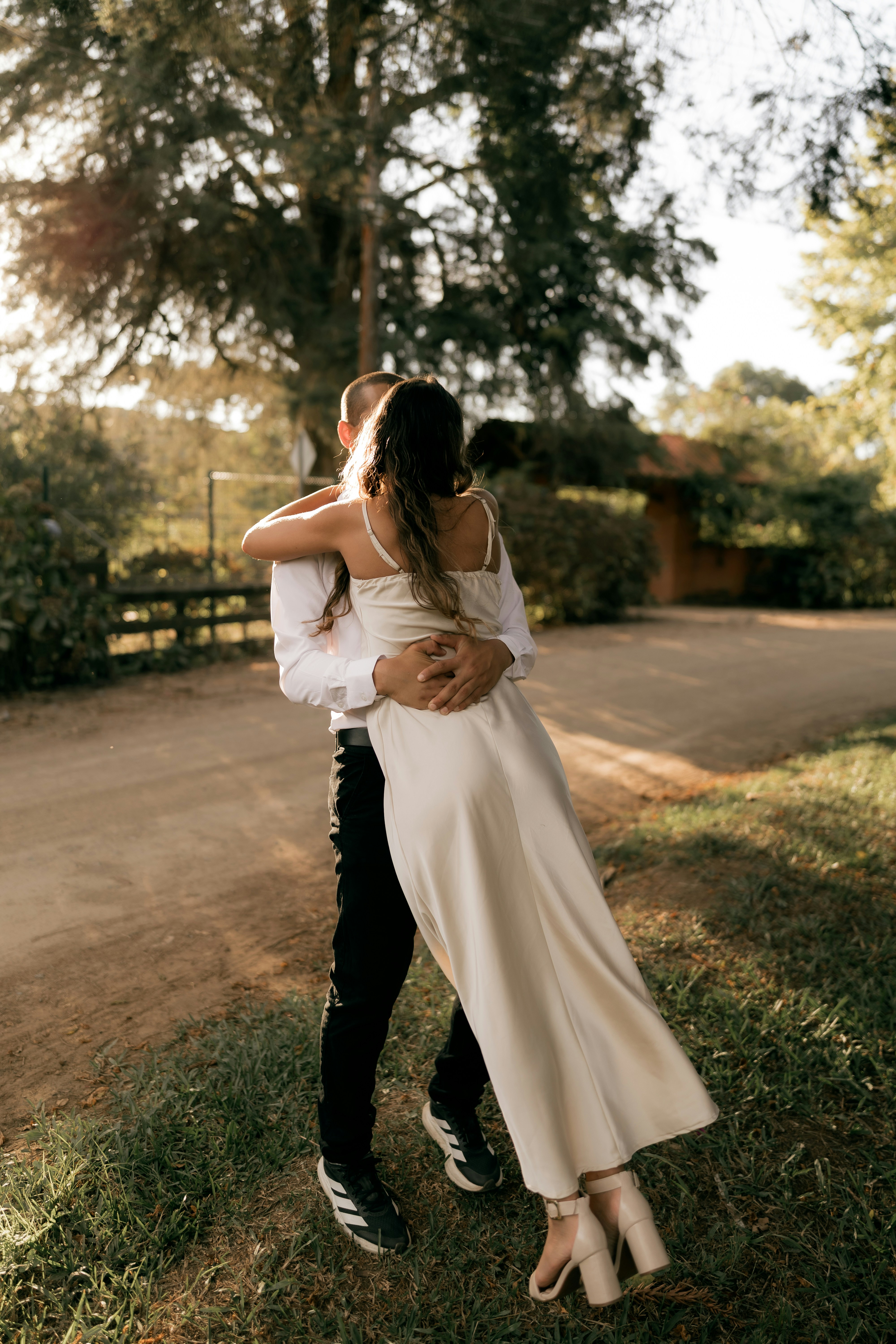 Embrace on the Path: A Quiet Dance in Sunlit Moment