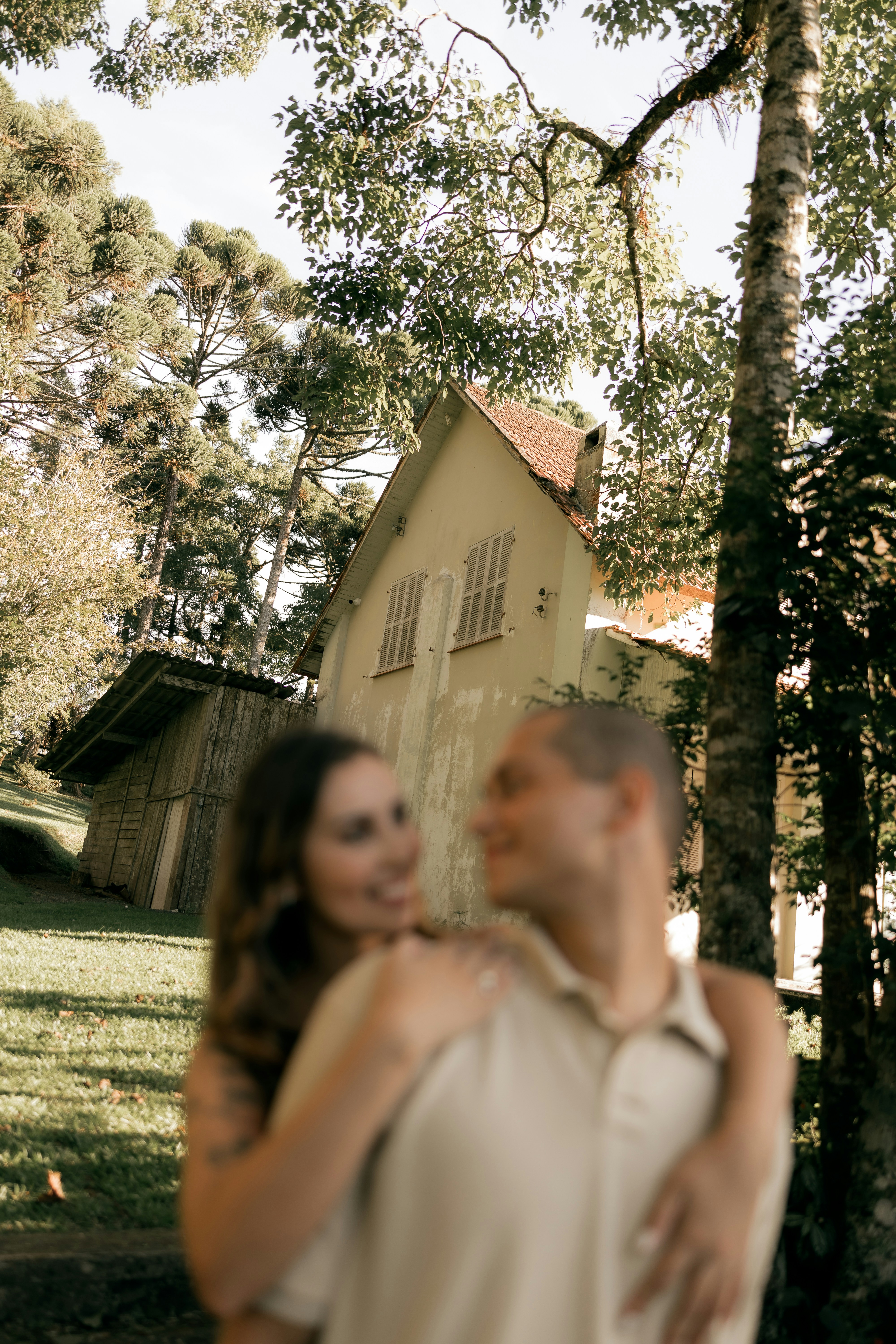 Blurred Portrait in a Sunlit Garden with a Charming Cottage