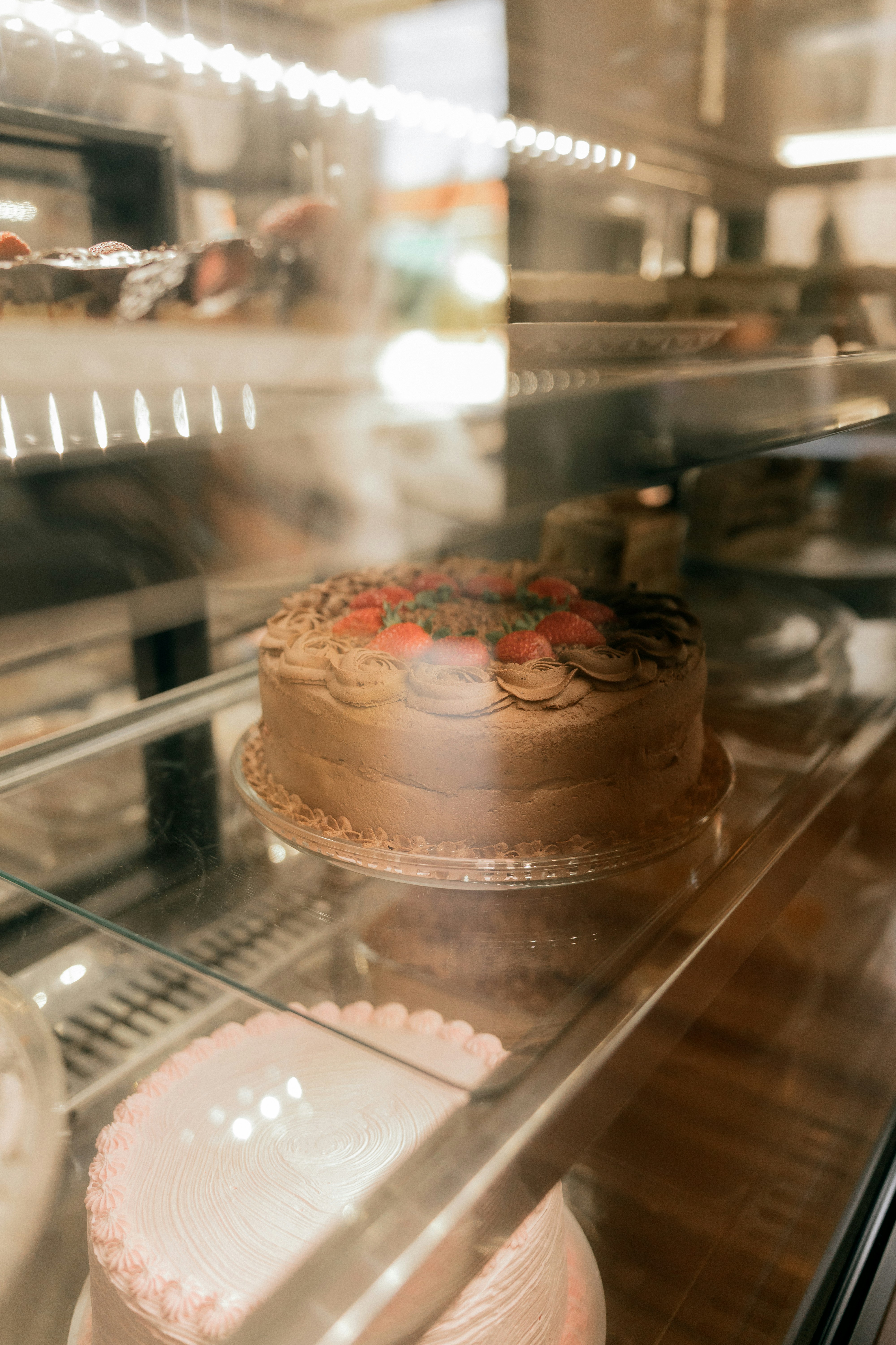 Warm Cake Display in a Glass-Front Bakery Case