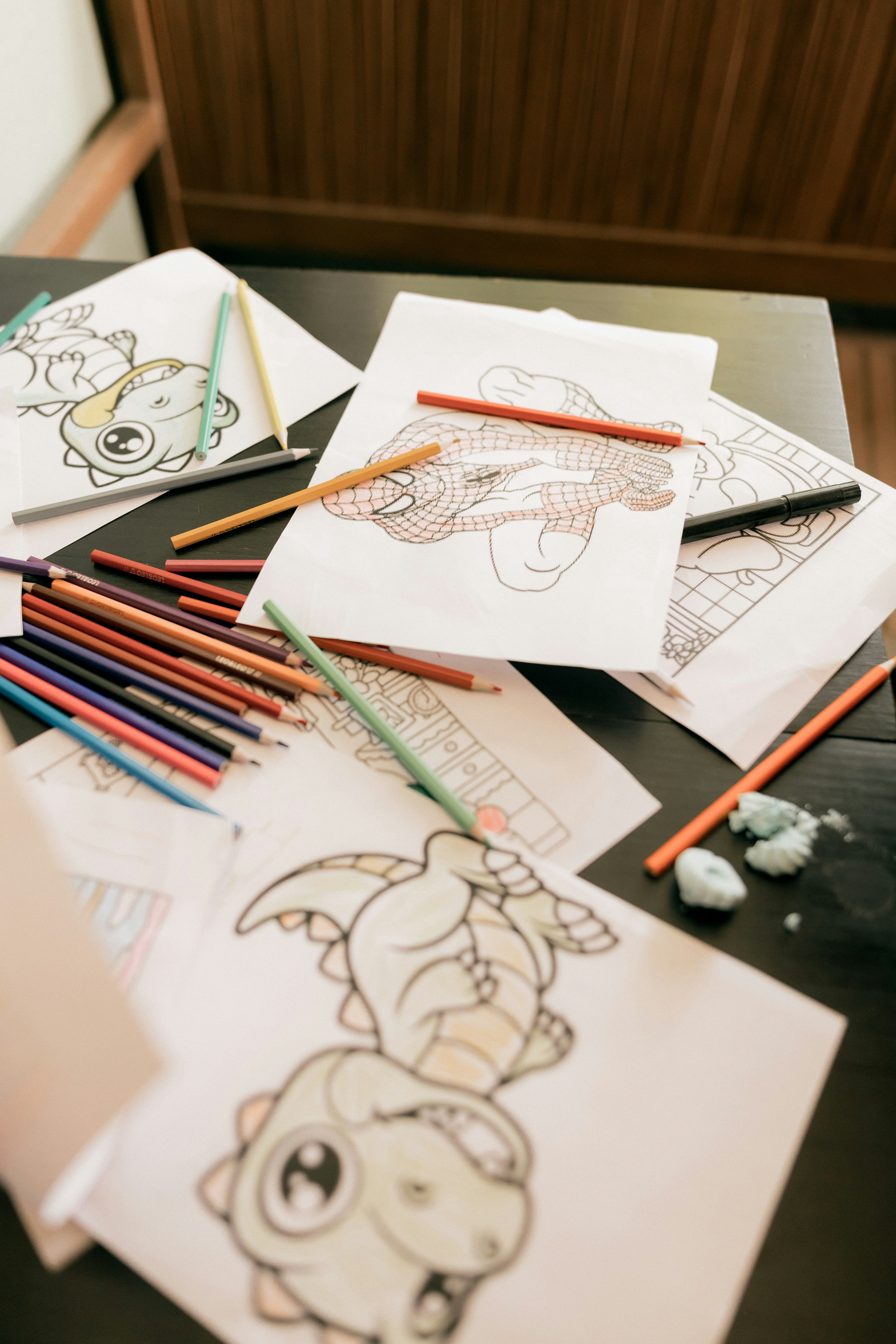 Sketches on a Sunlit Table: Colored Crayons and Creature Doodles