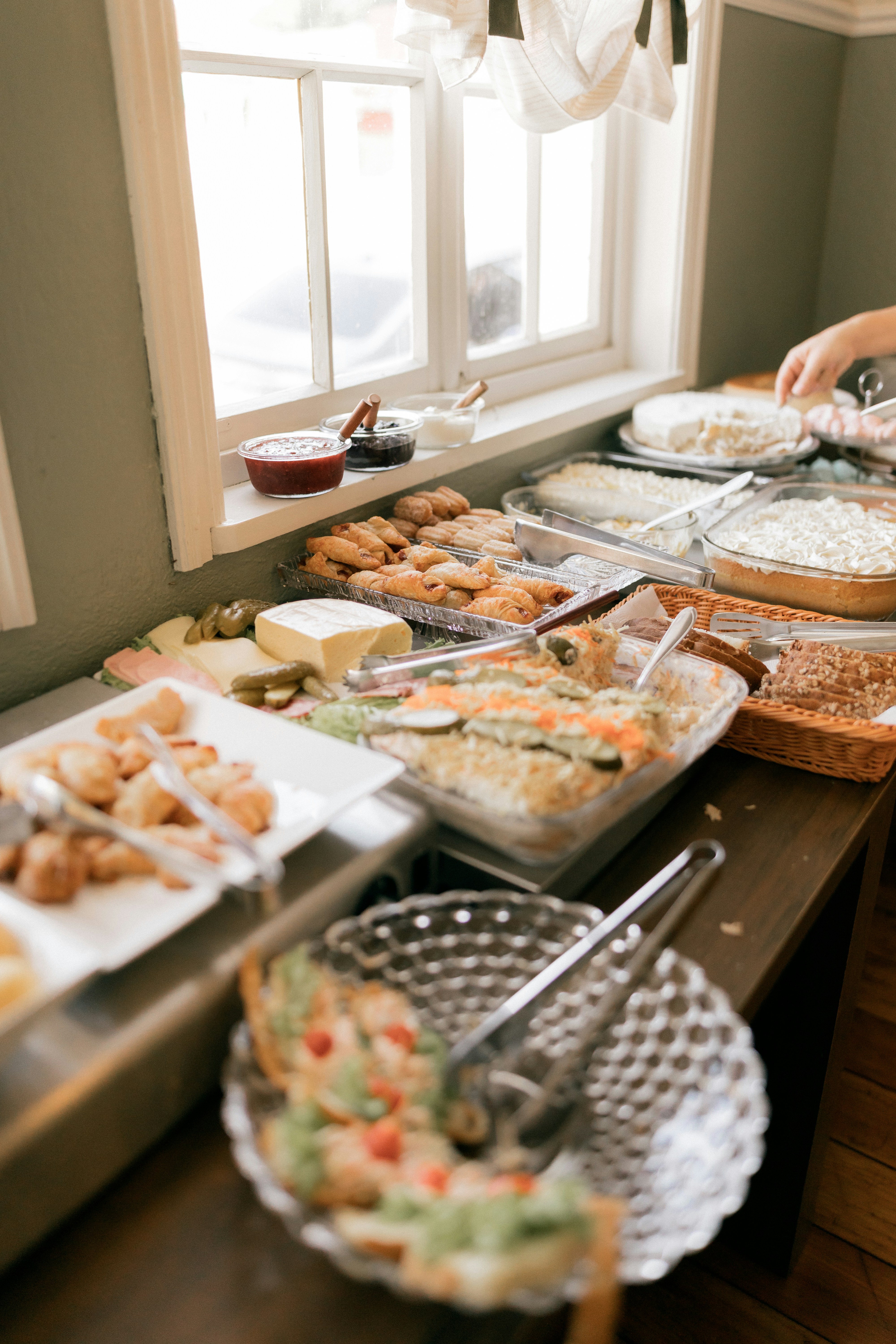 Succulent Spread: A Cozy Buffet of Pastries and Savories by a Shaded Window
