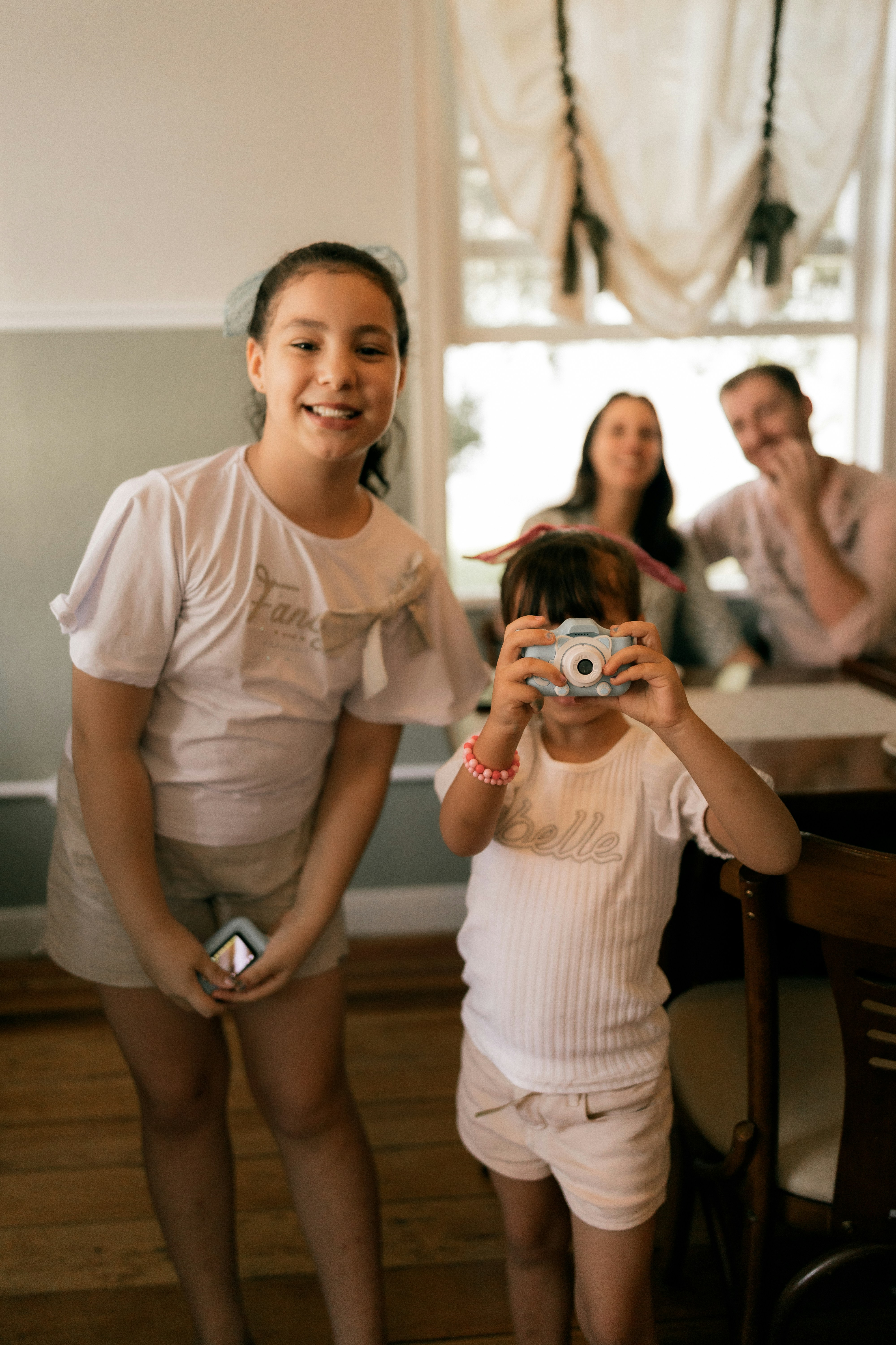 Smiling Trio with a Little Photographer in Focus