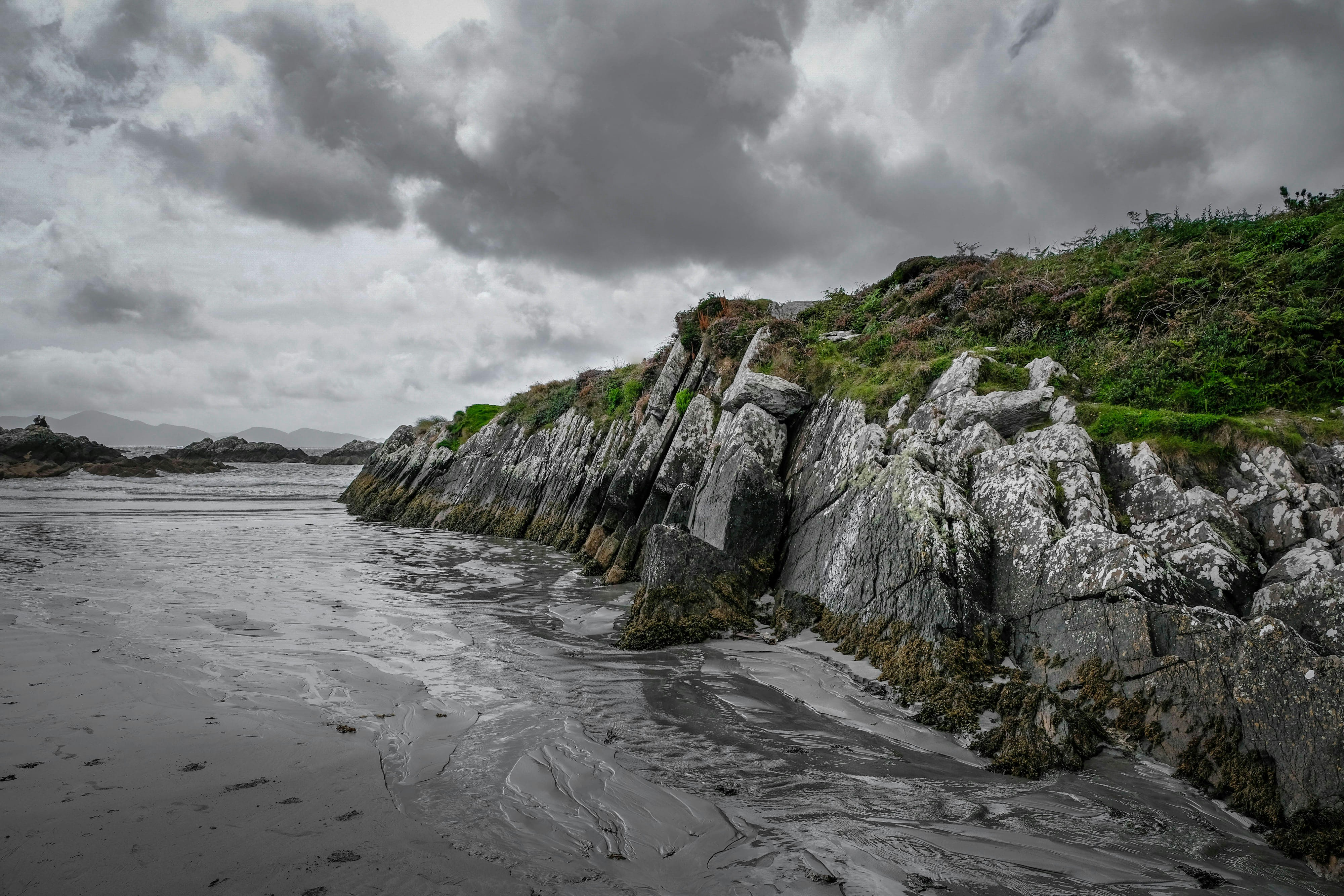 Rugged shoreline cliffs under brooding sky