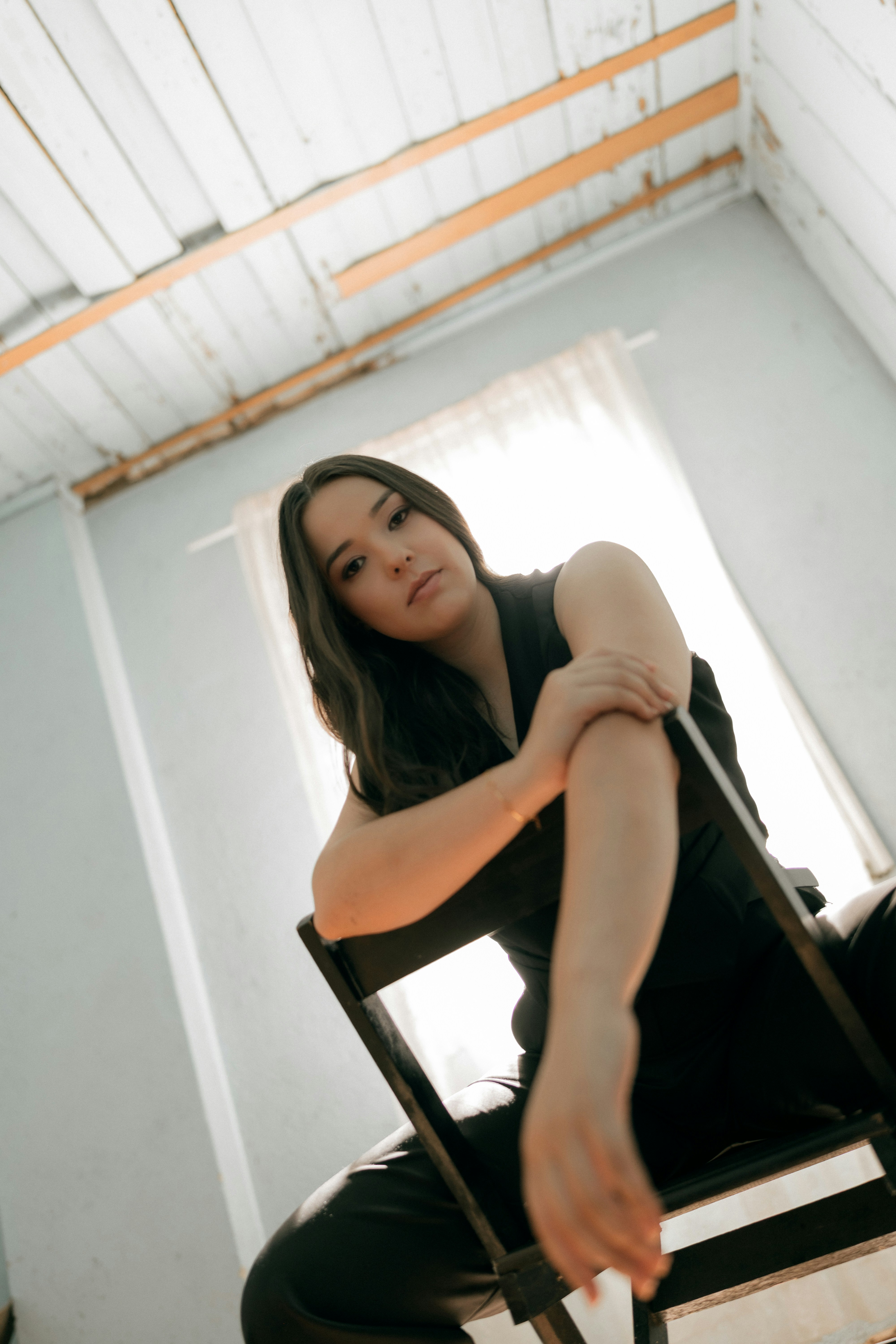 Loosened in Light: A Quiet Portrait on a Sunlit Stool