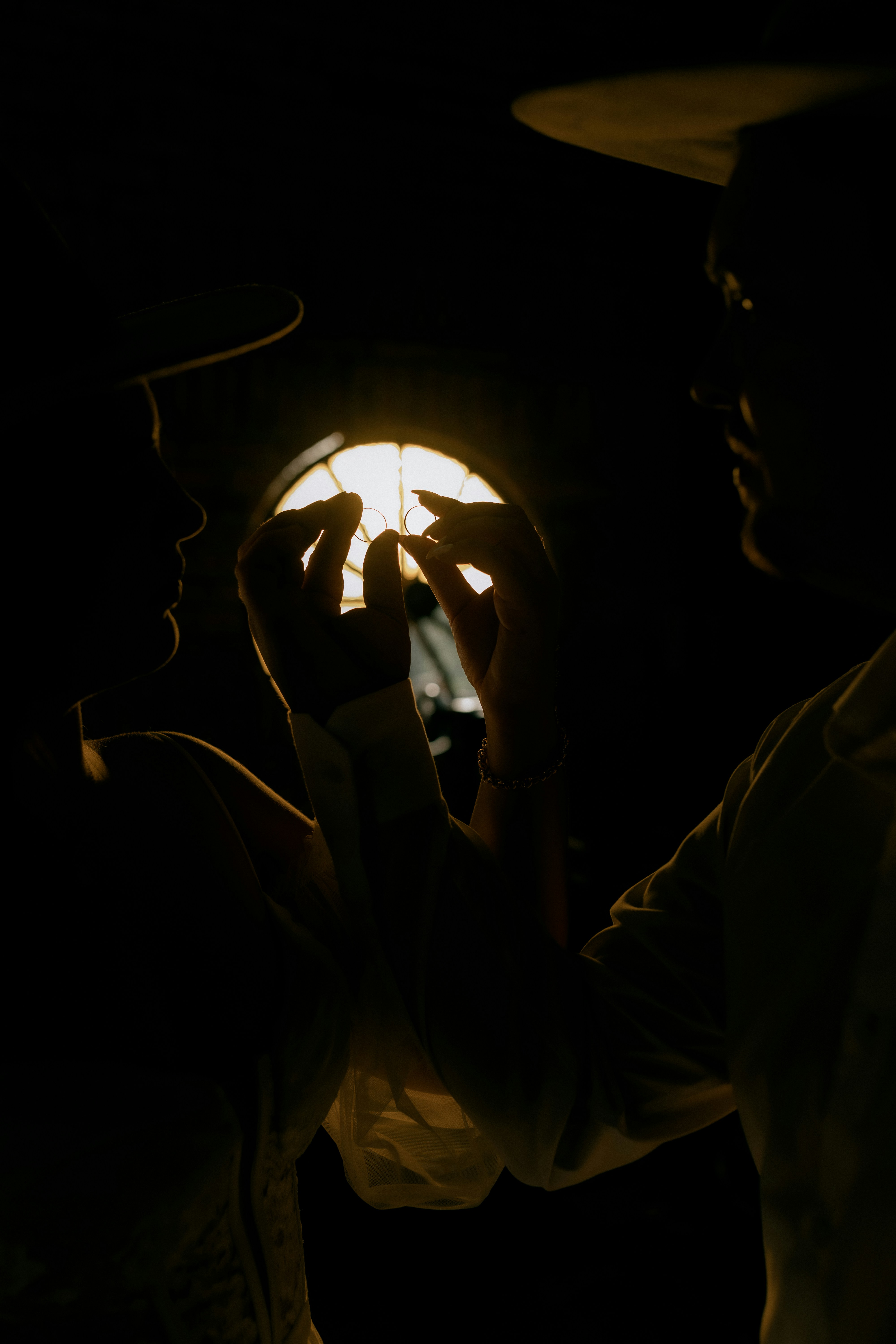 Silhouette of a Quiet Union: Hands cradling a warm glow