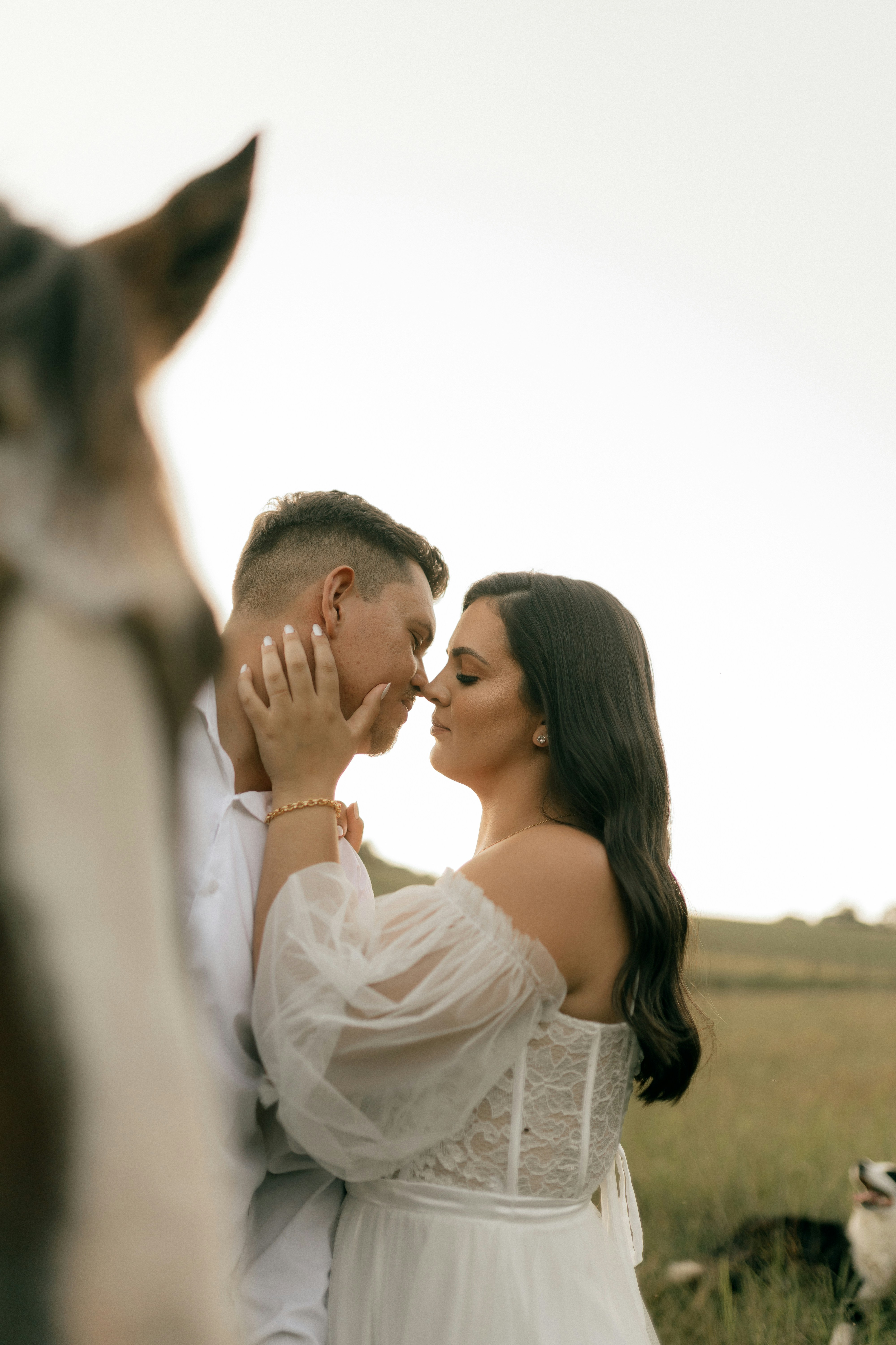 Close-Front Vows: Intimate Kiss Amid Open Field