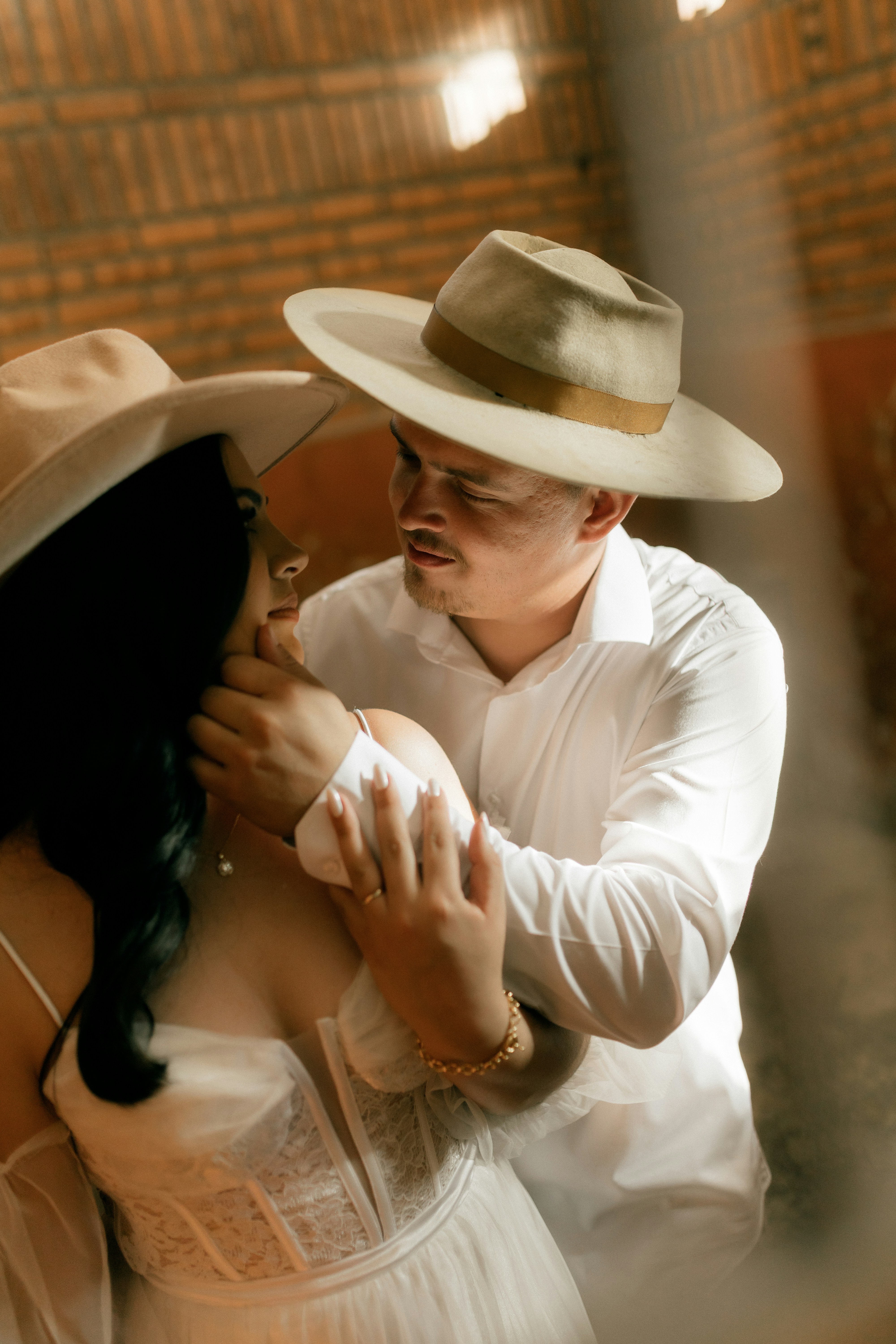 Near-Horizontal Gentle Touch: A Couple in Soft Light and Straw Hats