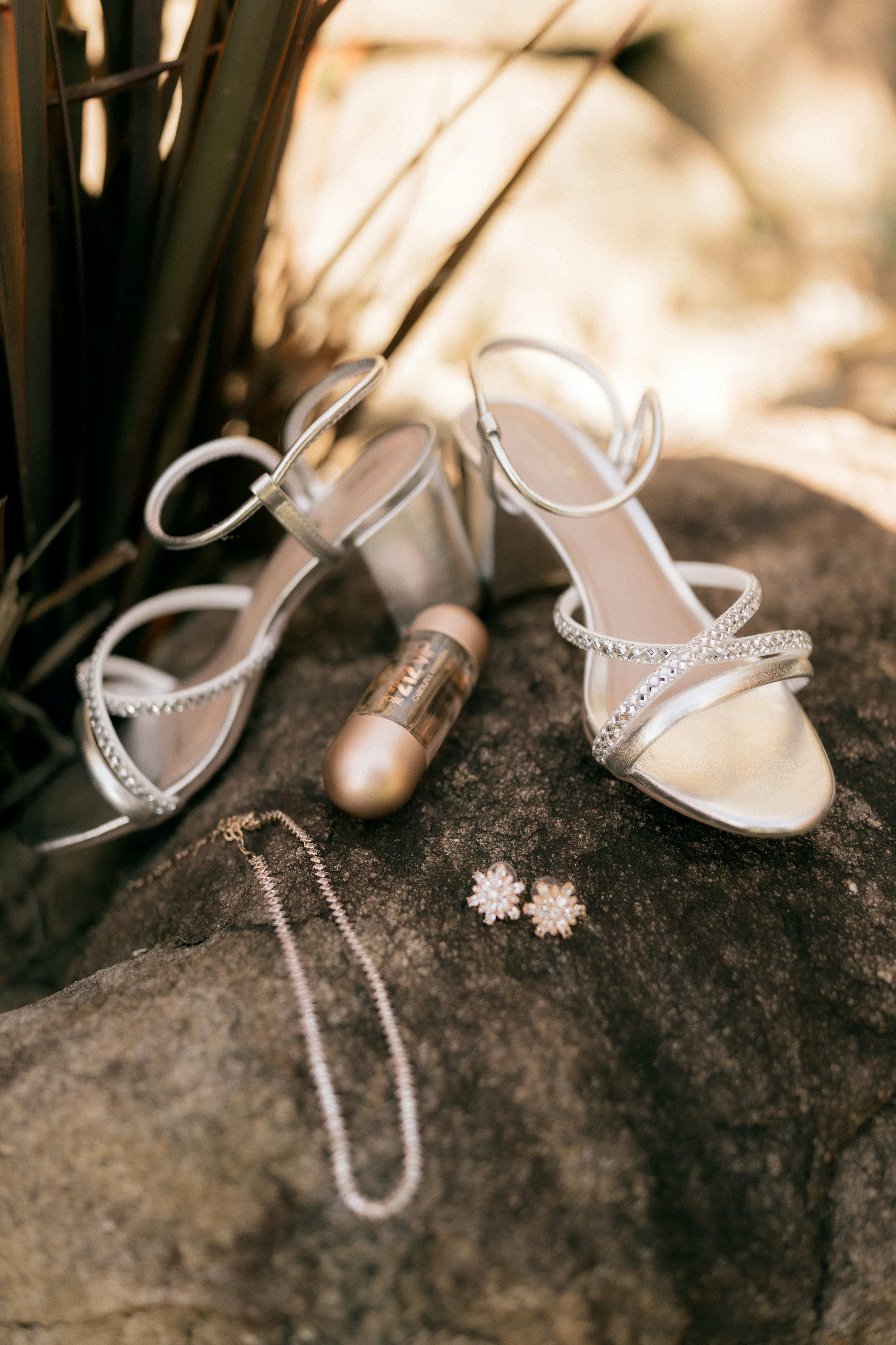 Silver Straps and Sparkle: Bridal Accessories Reclined on a Stone