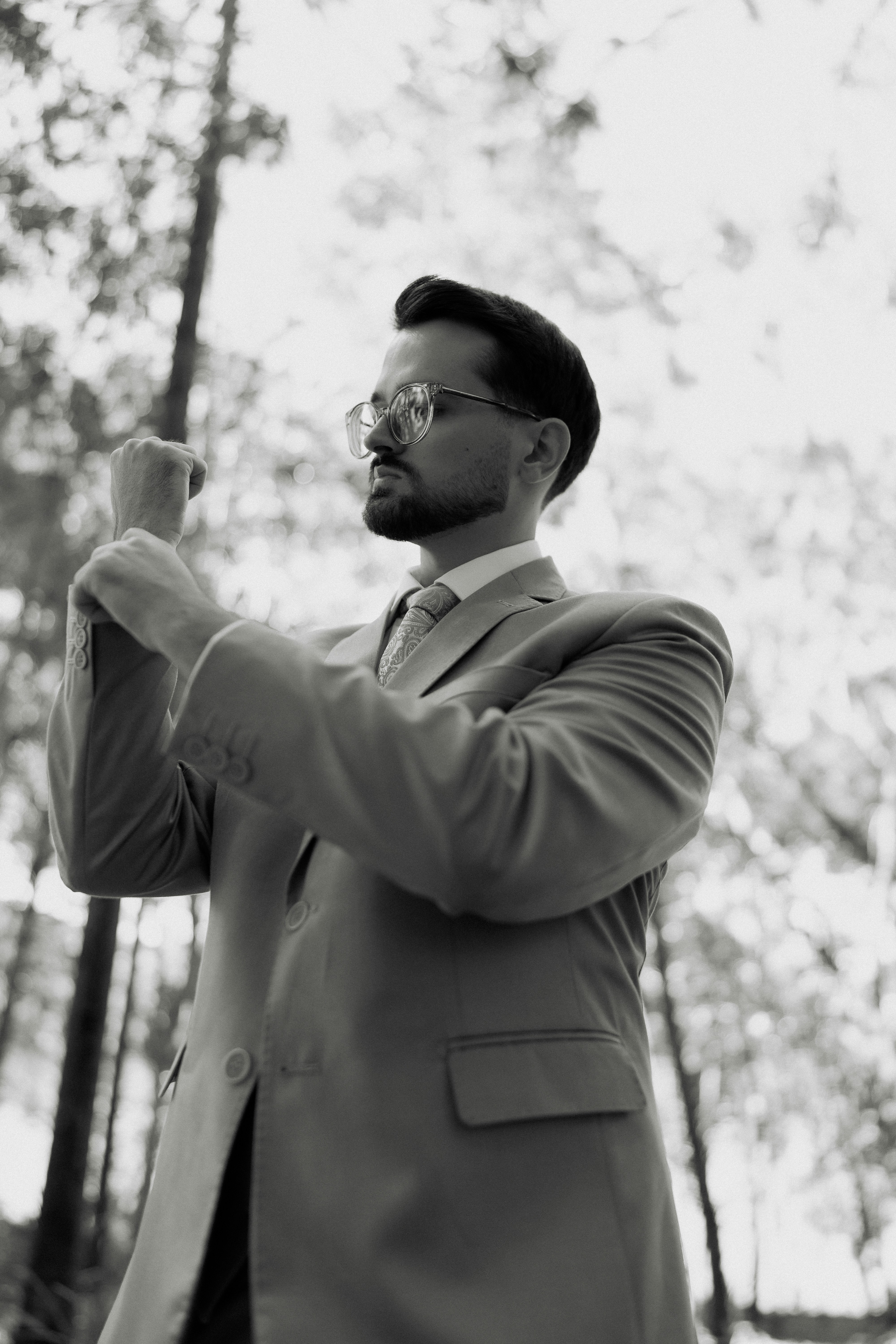 Groomed in Focus: A Gentleman Adjusts the Moment