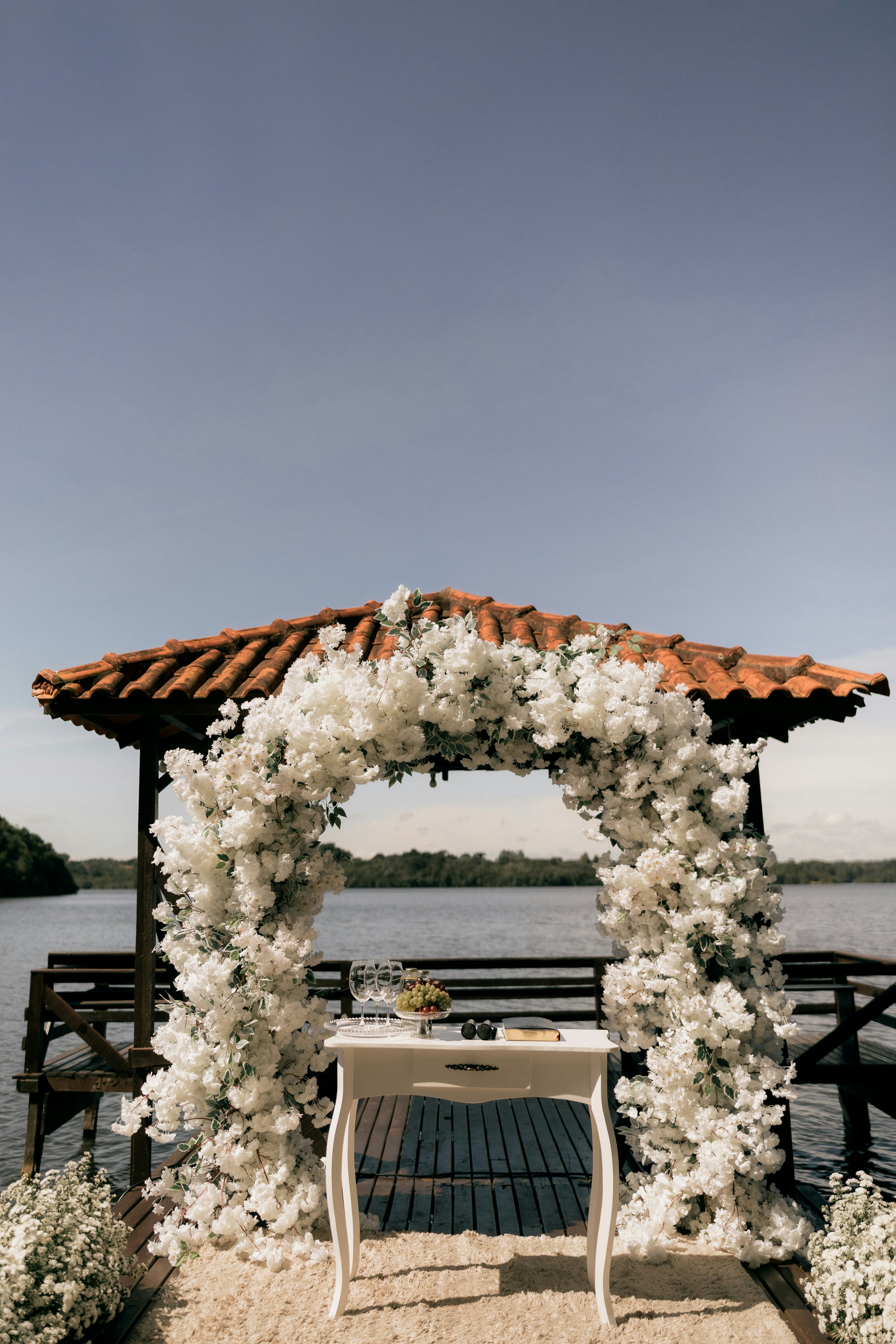 Floral Arch Over a Waterfront Altar