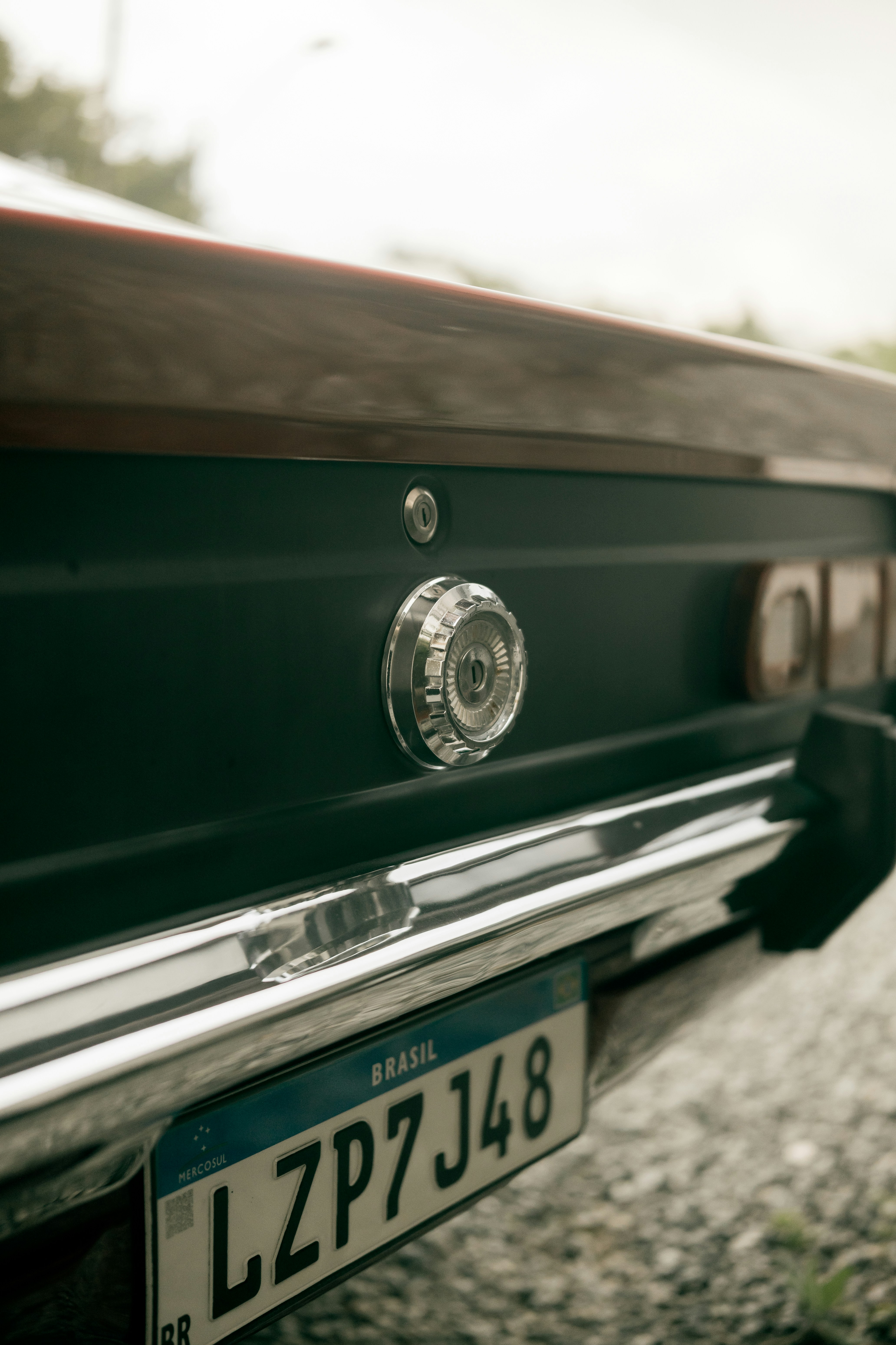 Tail Light Echoes: A Vintage Brazil Plate on a Weathered Car