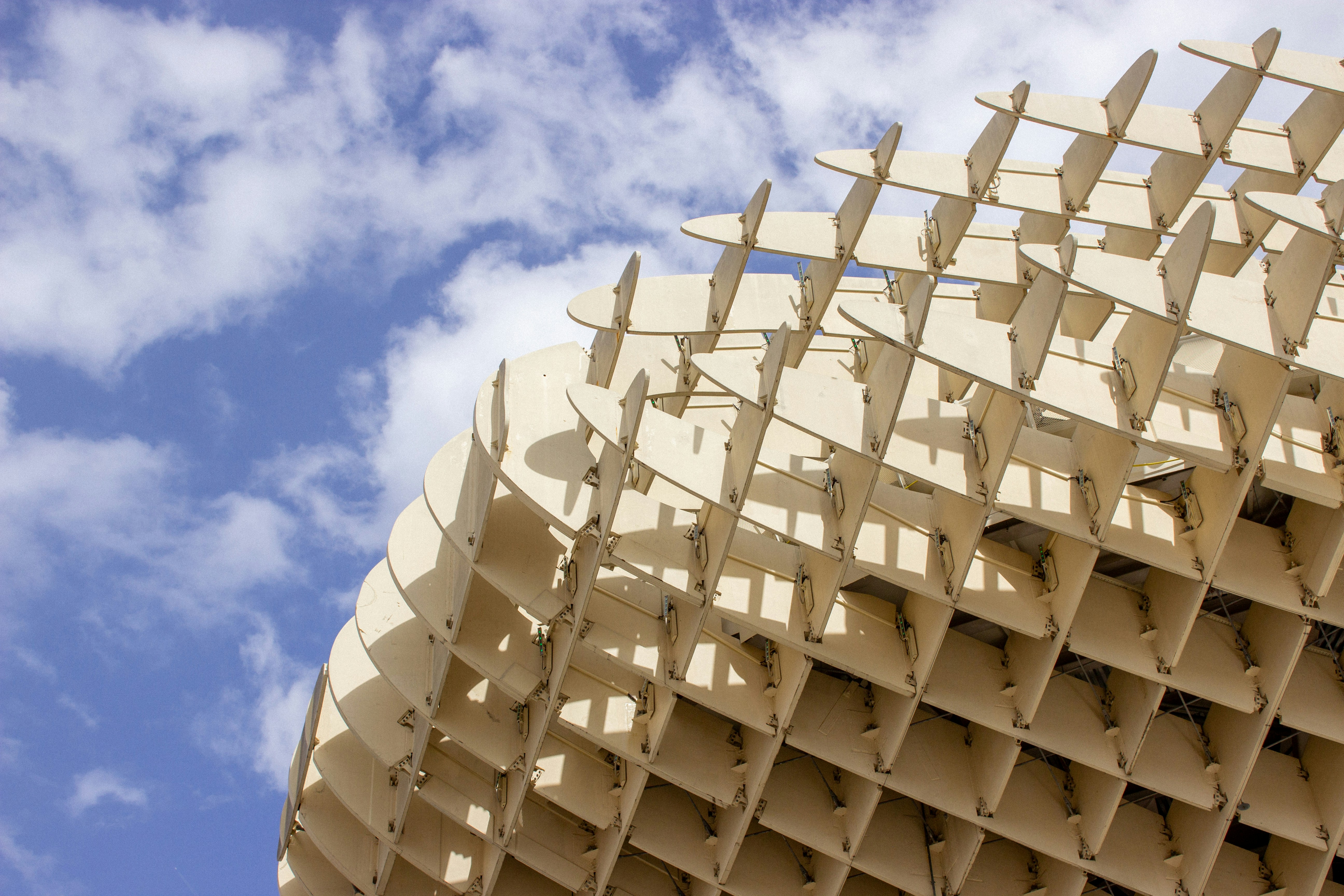 Lattice Skyscraper: Sunlit Curves of Geometric Facade Against a Blue Sky