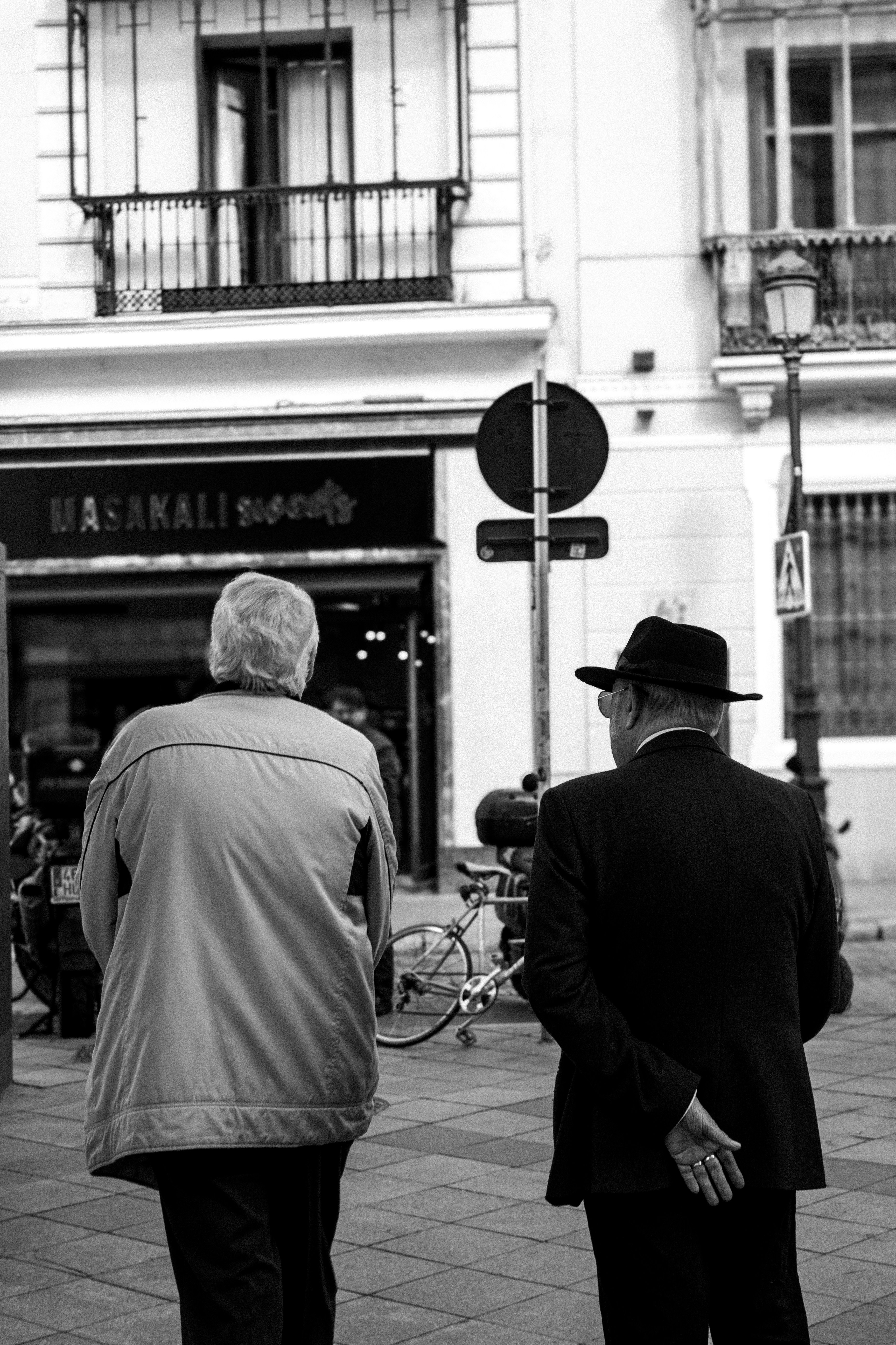 A Quiet Exchange: The Odd Couple of an Elder Gentleman and a Shadowed Stranger