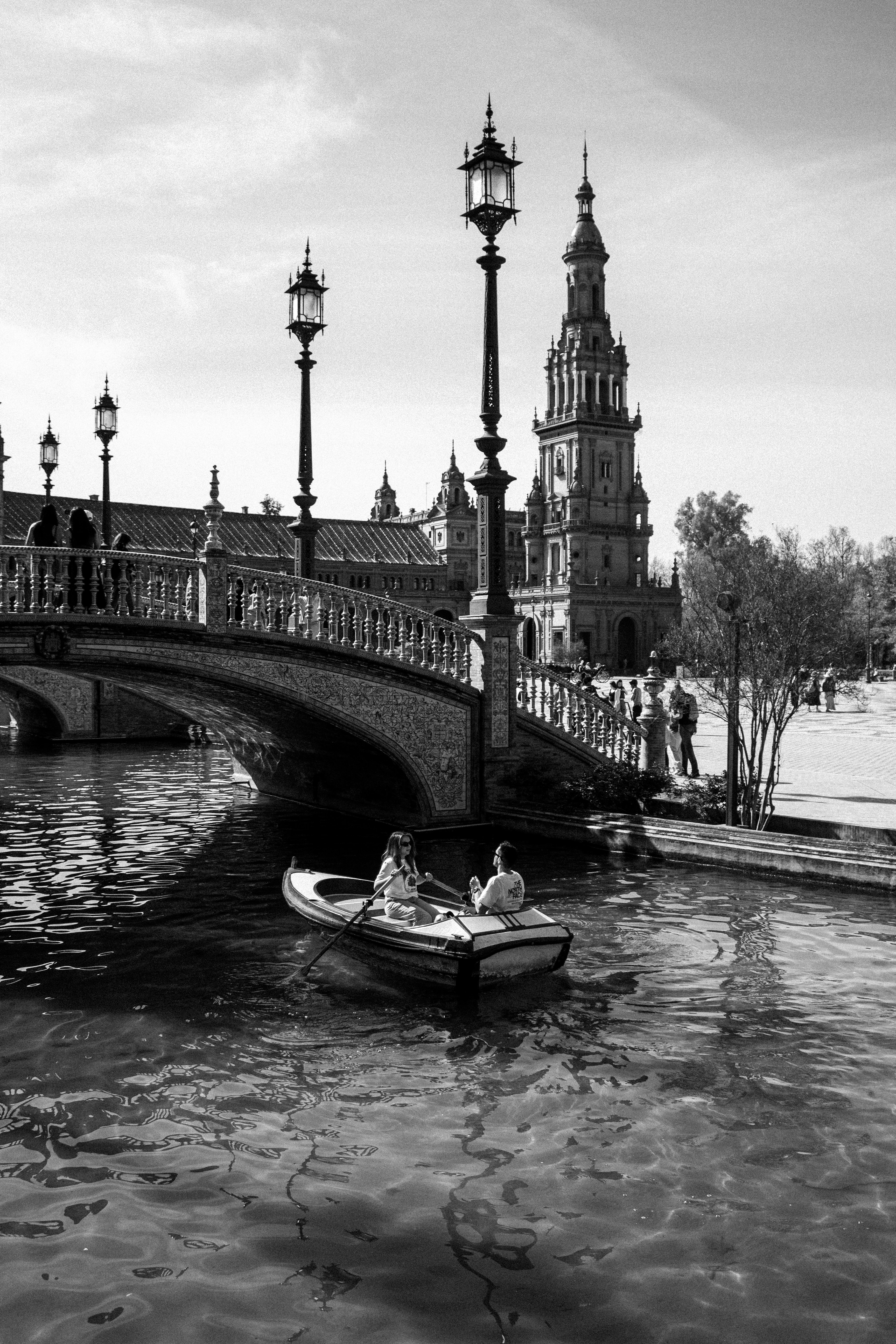 A Quiet Boat Under the ornate bridge by the grand tower