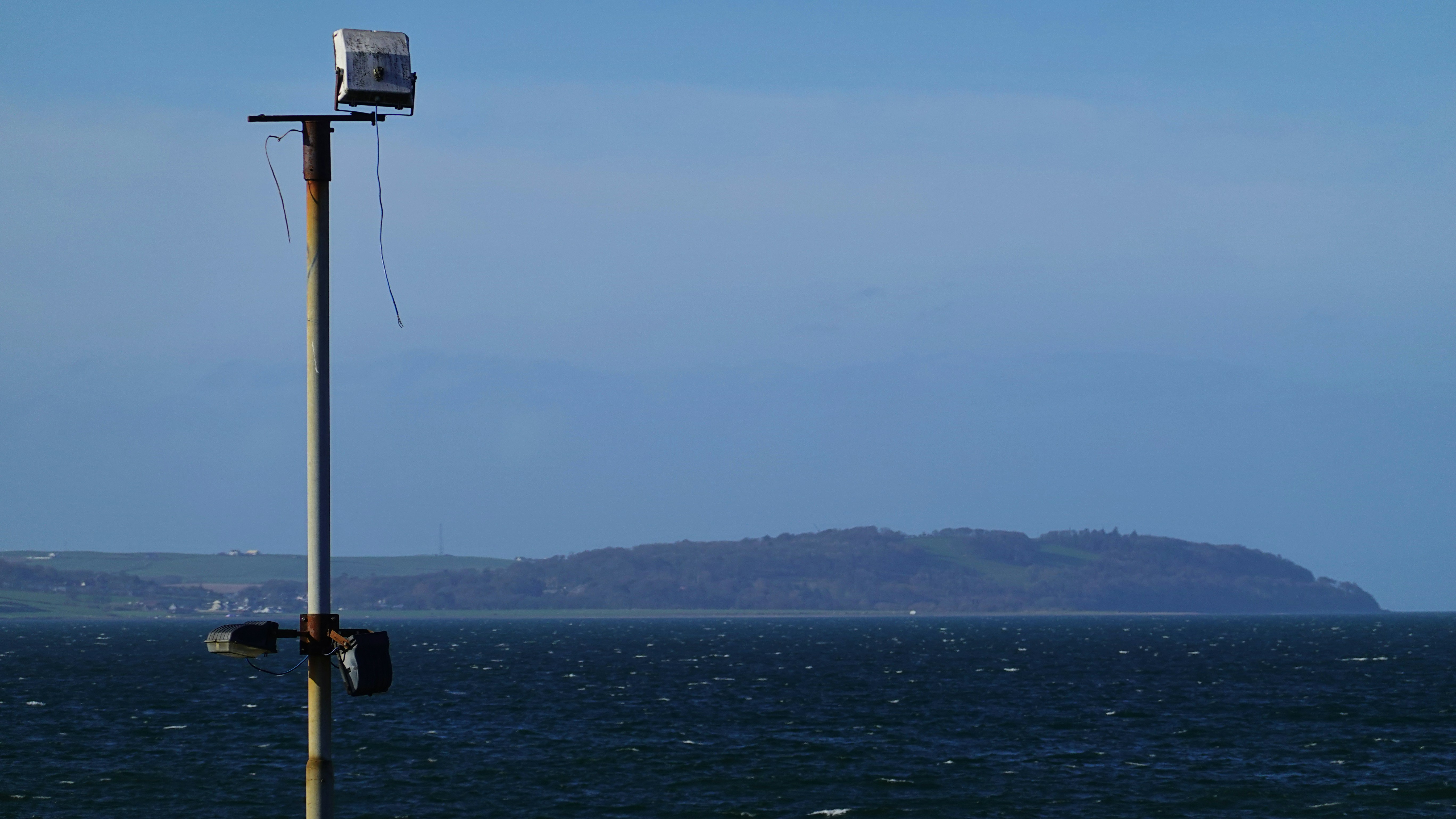 Harbor Perch: A Minimal Distant Sentinel Over the Sea