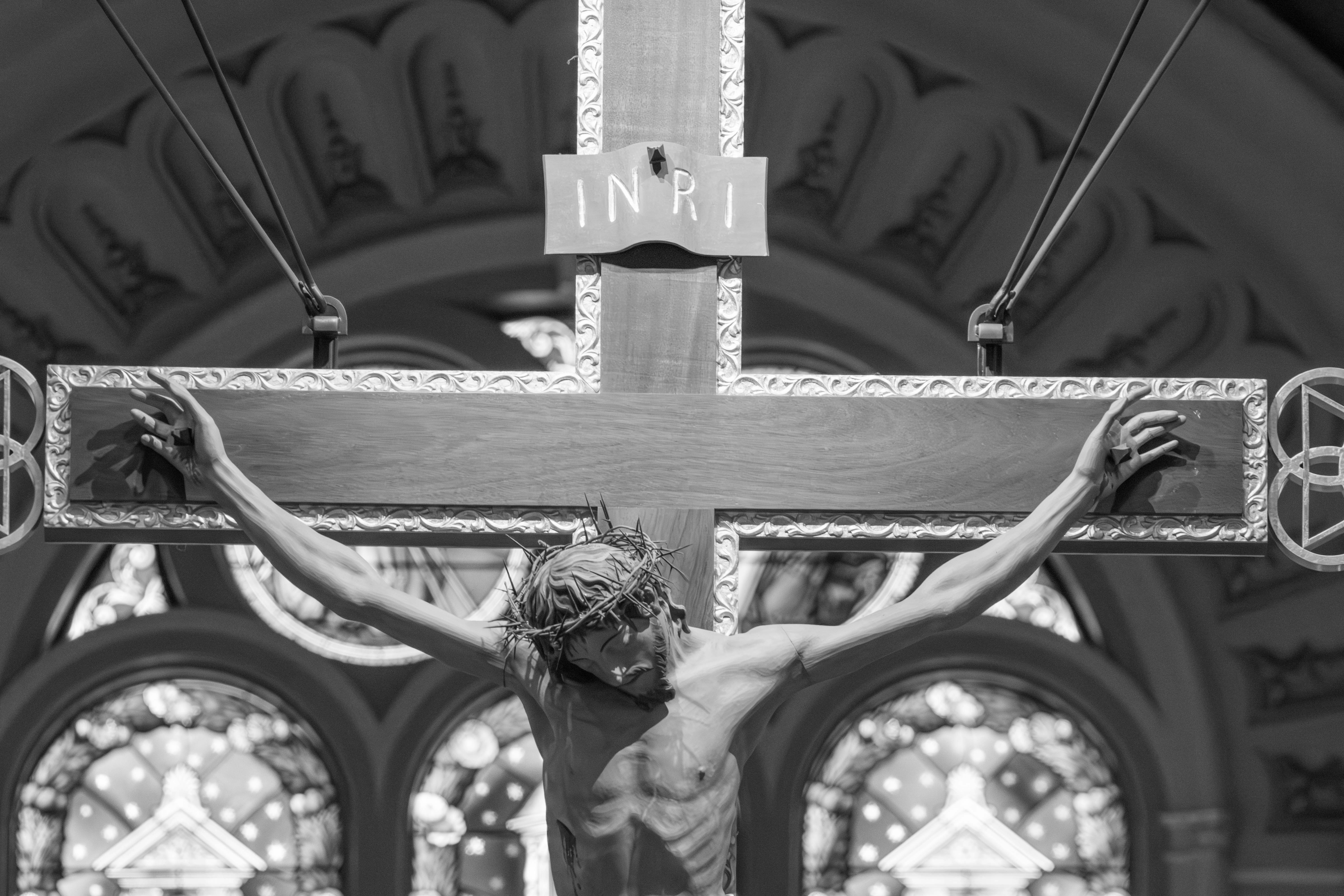 Cruciform Silhouette: A Solemn Moment Beneath the Cathedral Cross