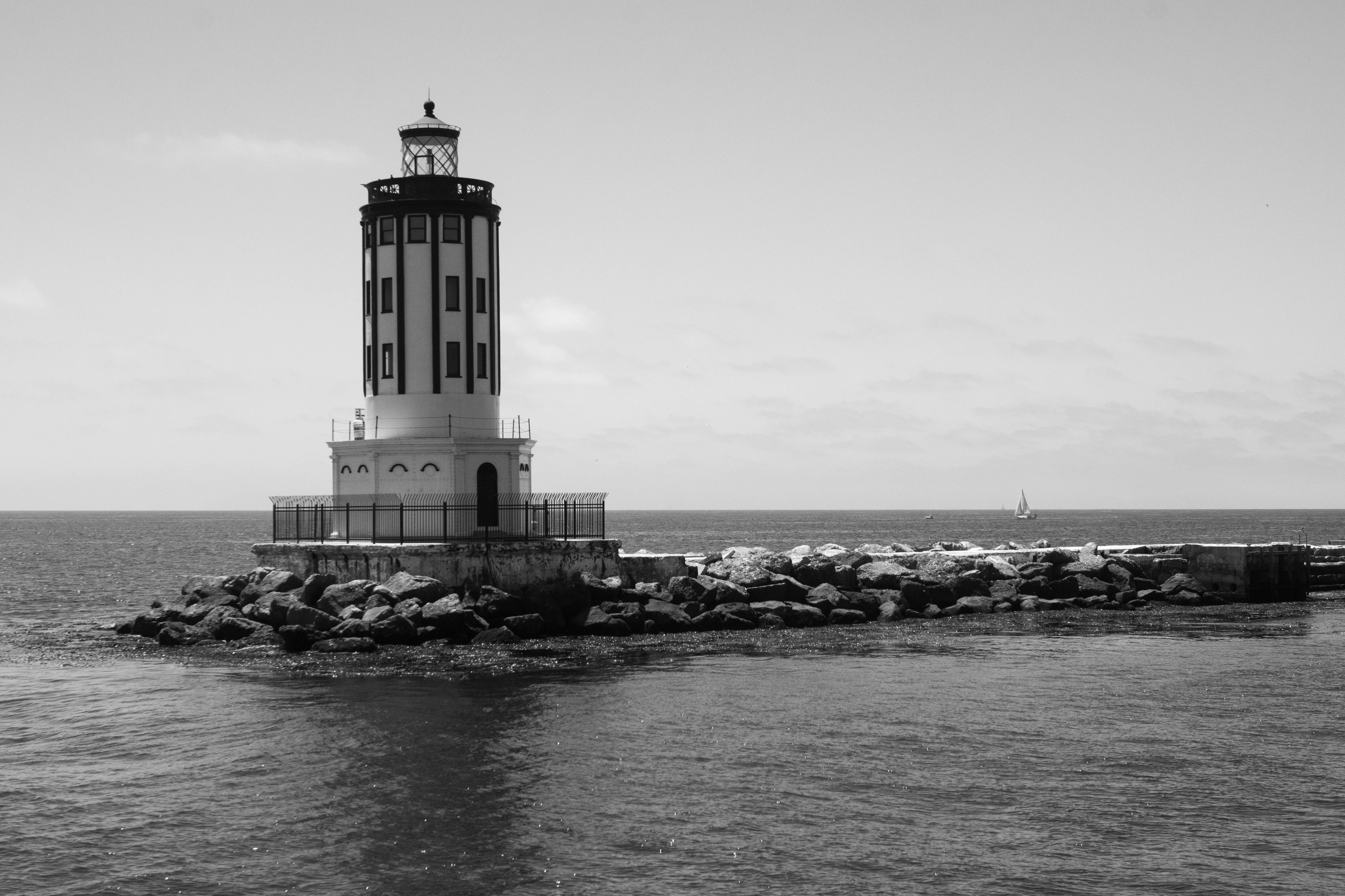 Lighthouse on a Quiet Breakwater Beyond the Calm Sea