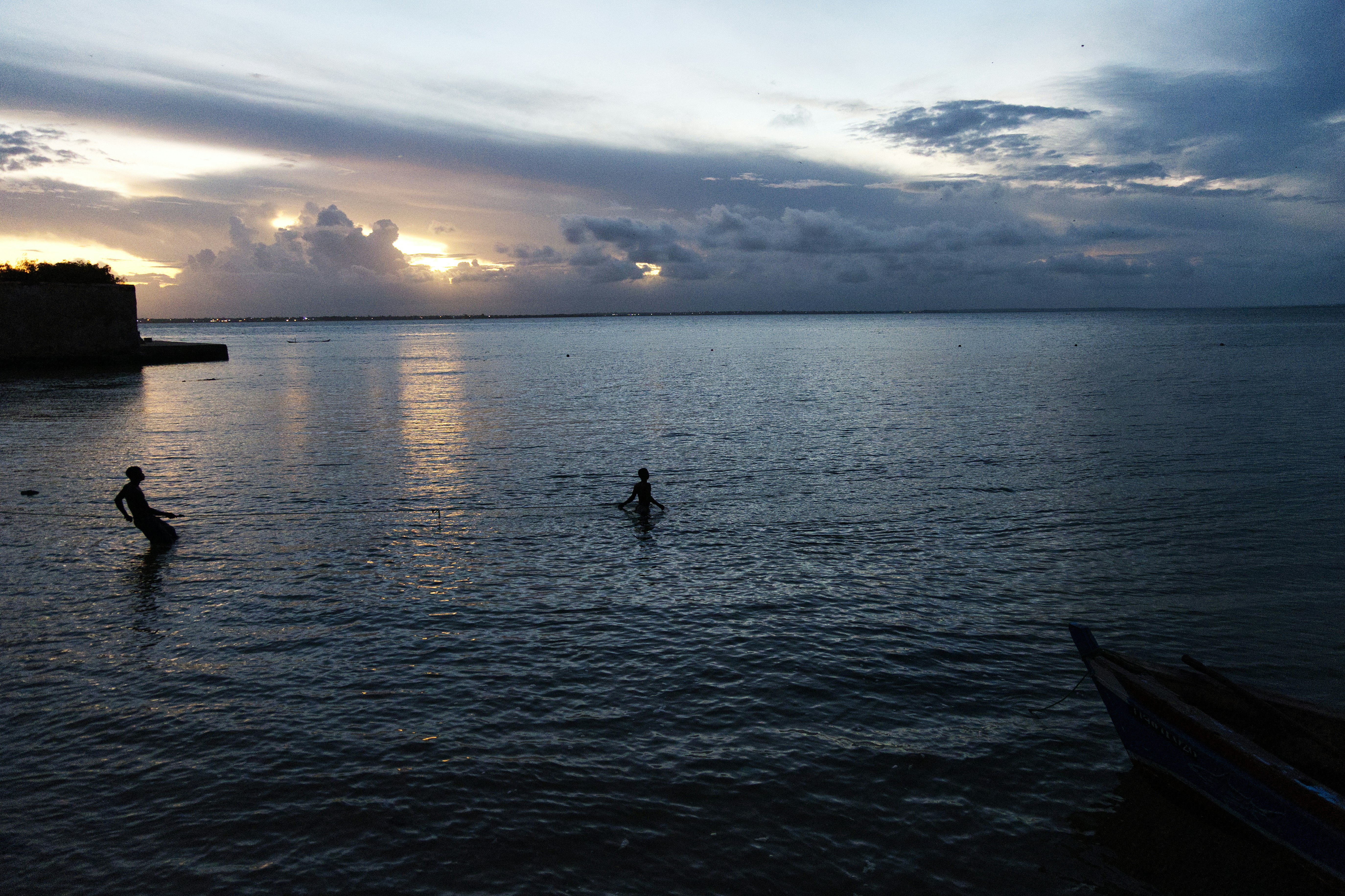 Horizon Crossing: Silhouetted Surfers at Dusk