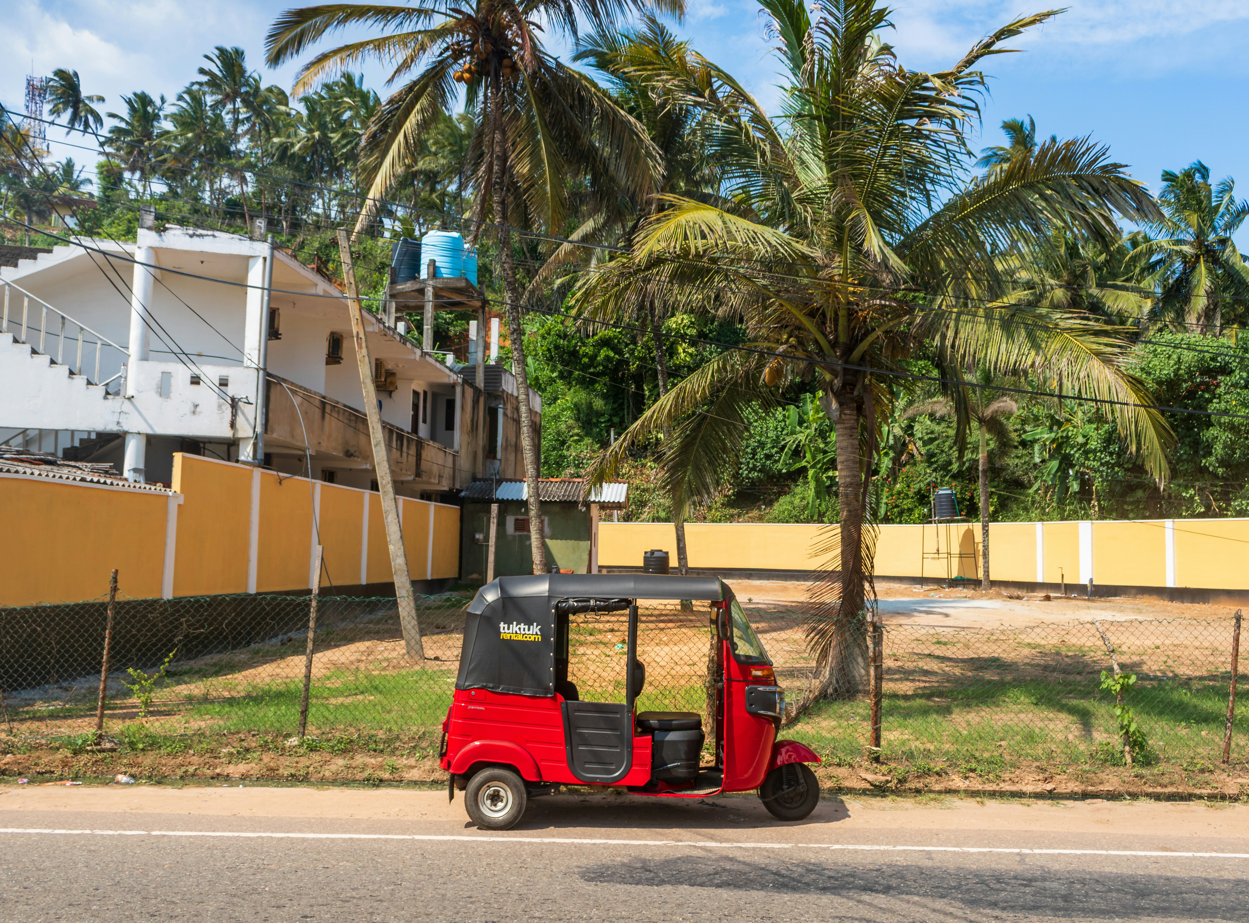 Red Tuk-Tuk at a Sunny Coastal Street