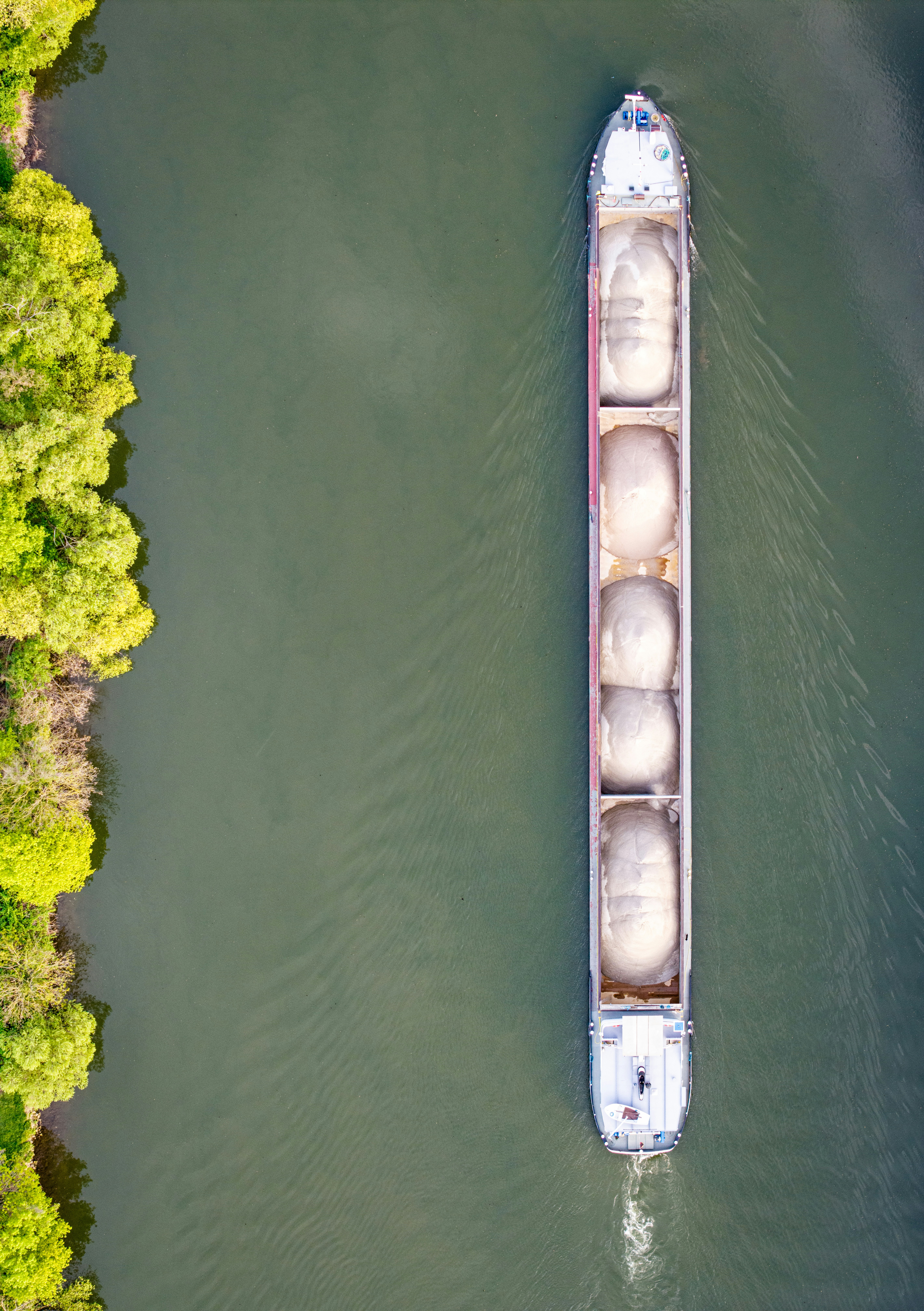 River Barge Aligned: Aerial Rail of Sand and Water
