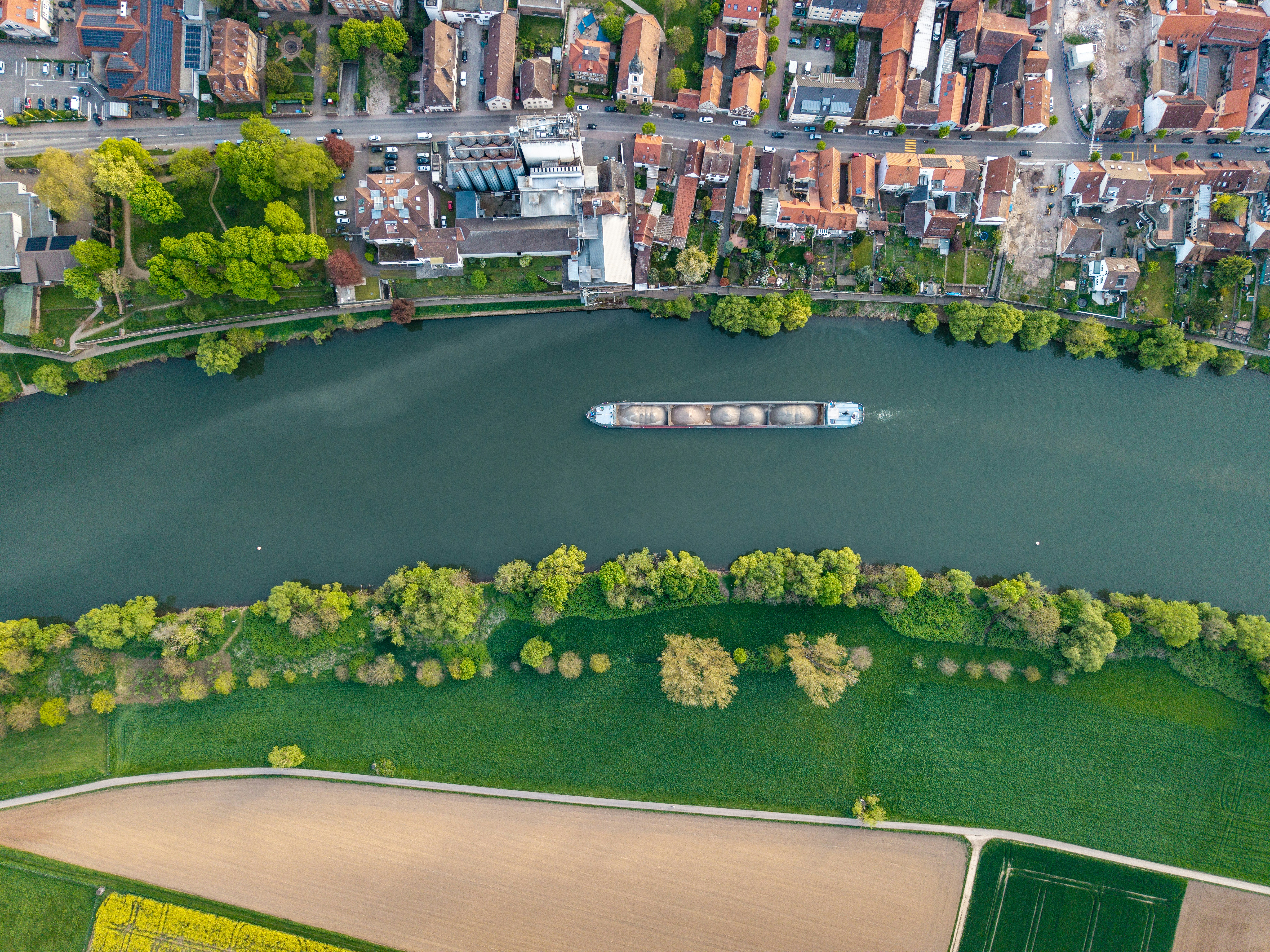 Riverside Cityscape: Aerial View of Park, Canal, and Row of Homes