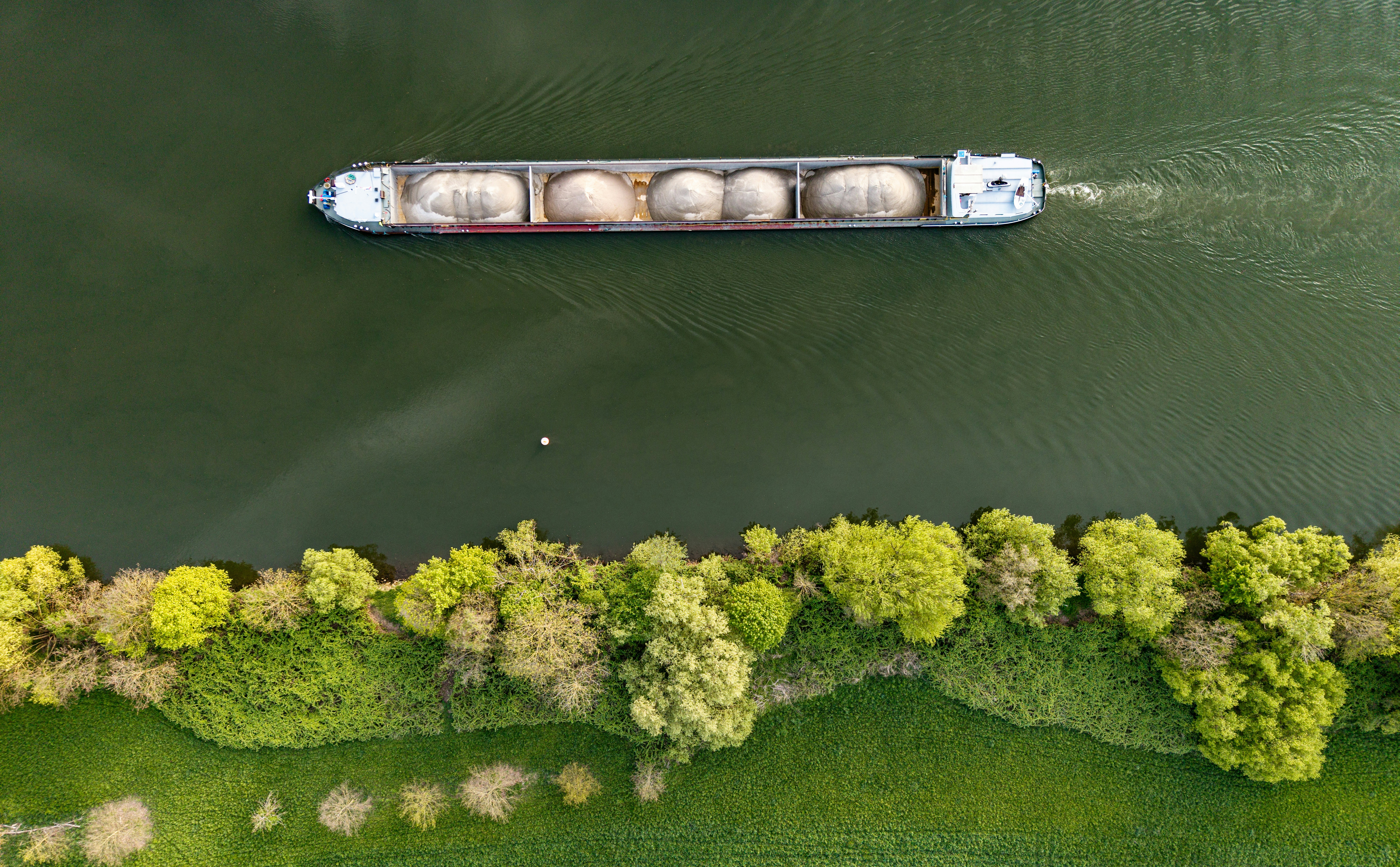 River Barge Traverses a Green Corridor
