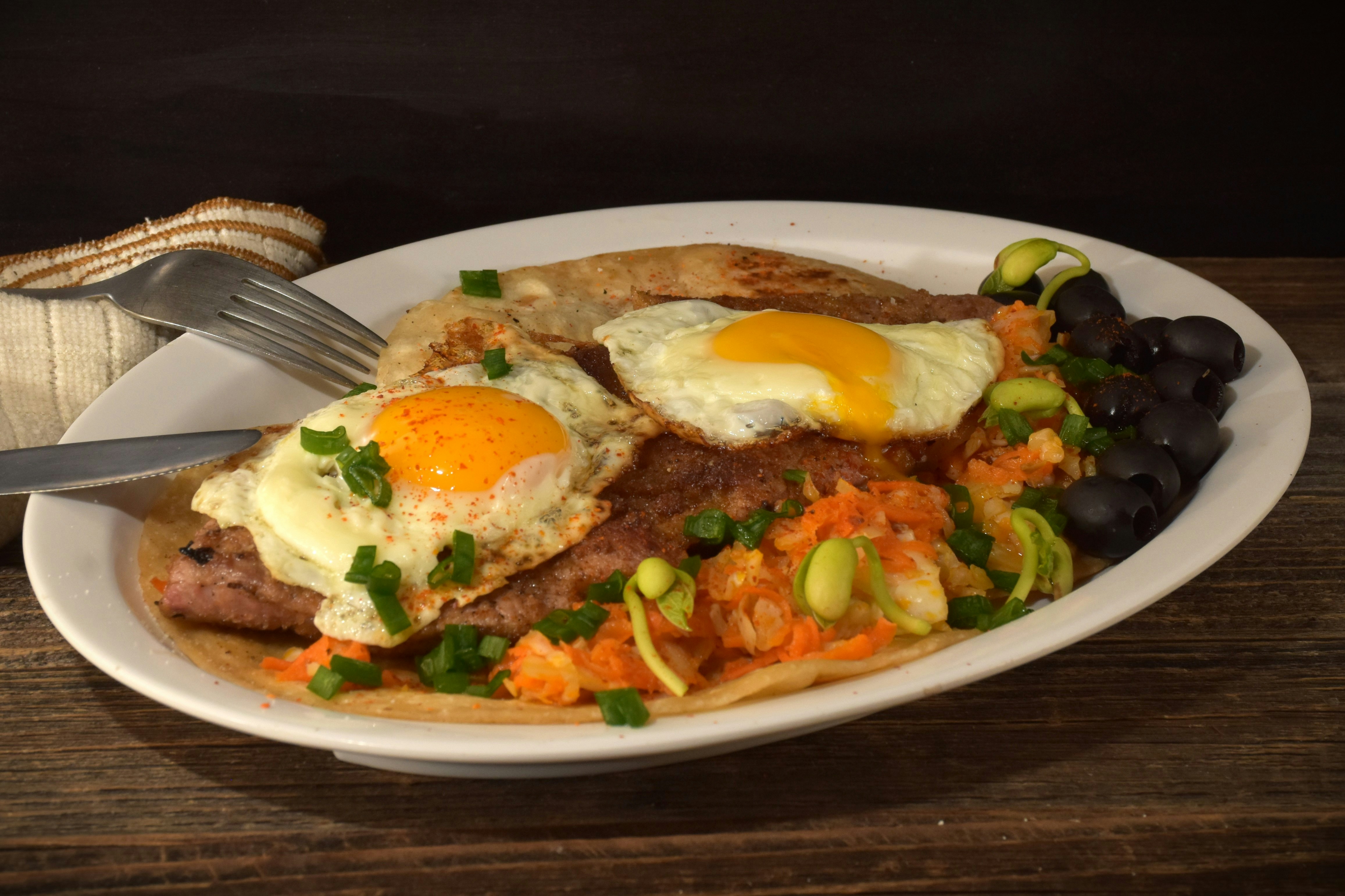 Sunny Fried Eggs and Grilled Steak Plate with Carrot Ribbons and Olives