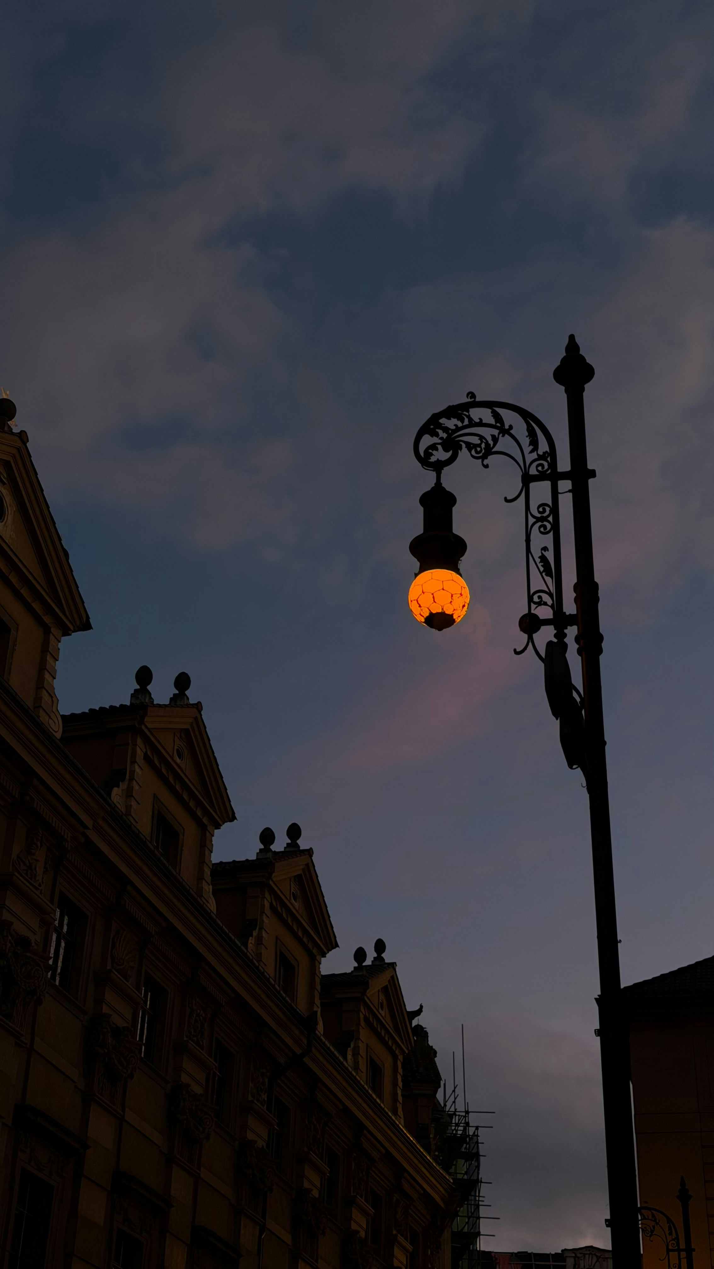 Amber Lantern in the Dusk over Ornate City Facades