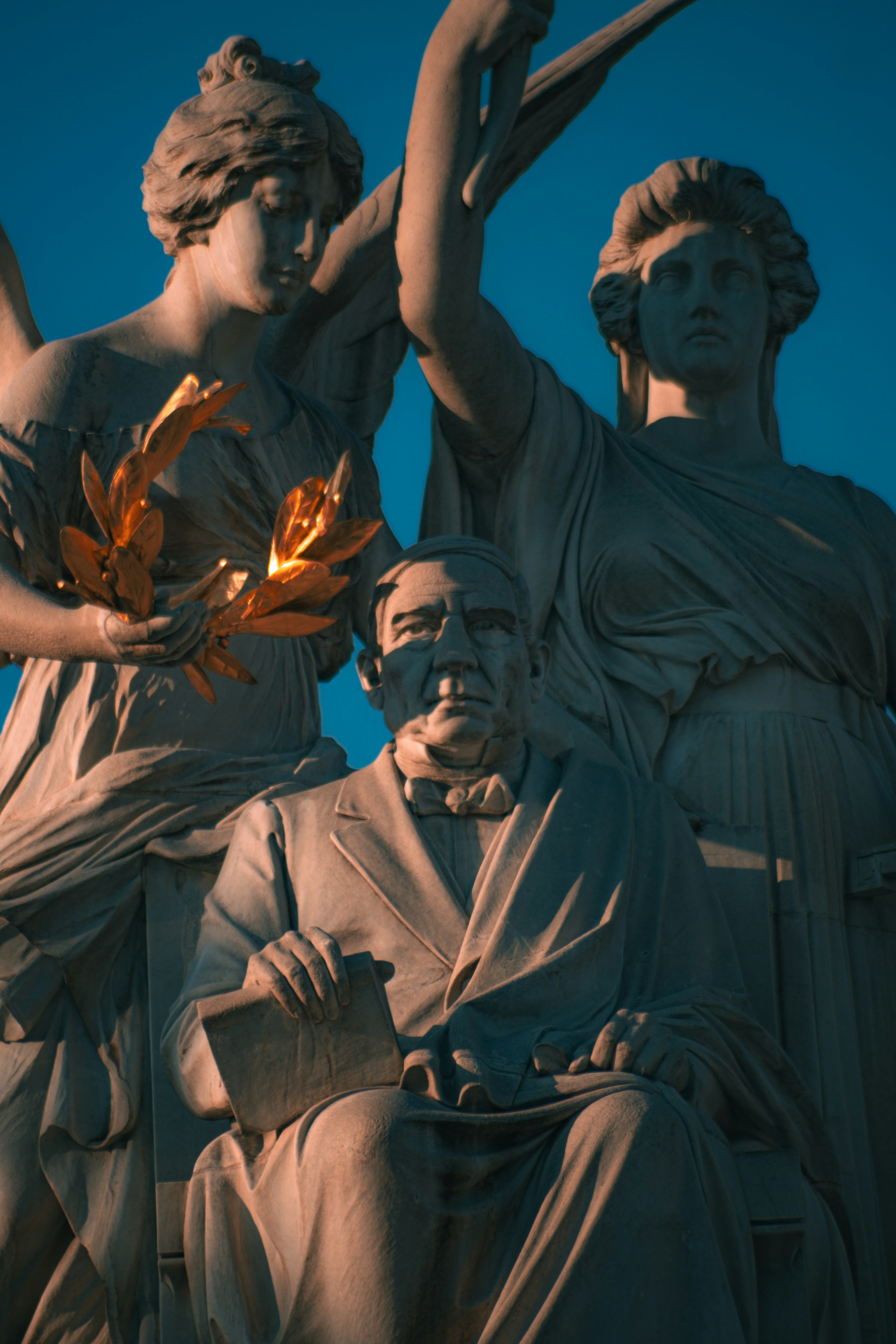Monumental Resolve: A Seated Matron with Winged Companions