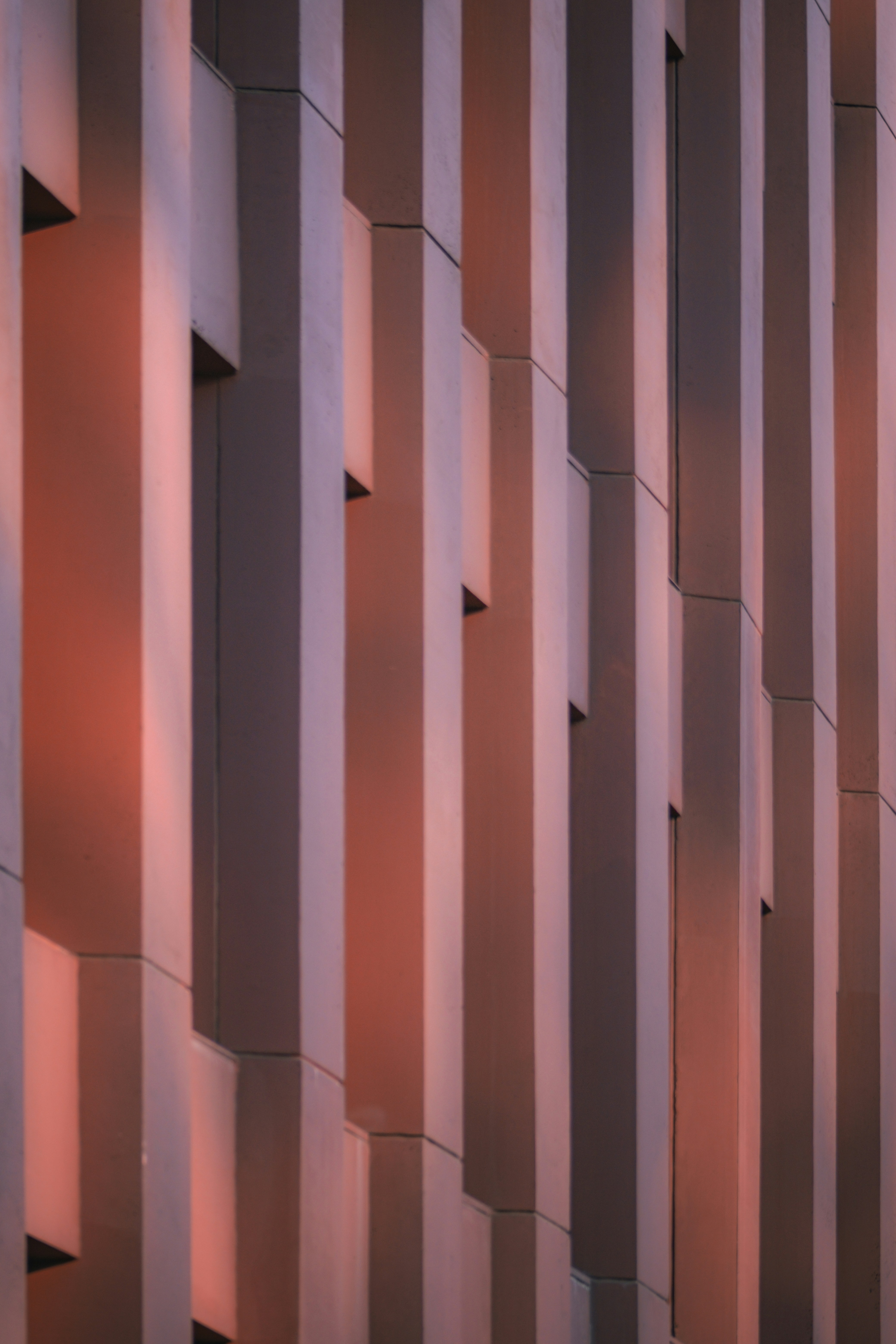 Vertical Echoes: Sunset Light on Faceted Facade