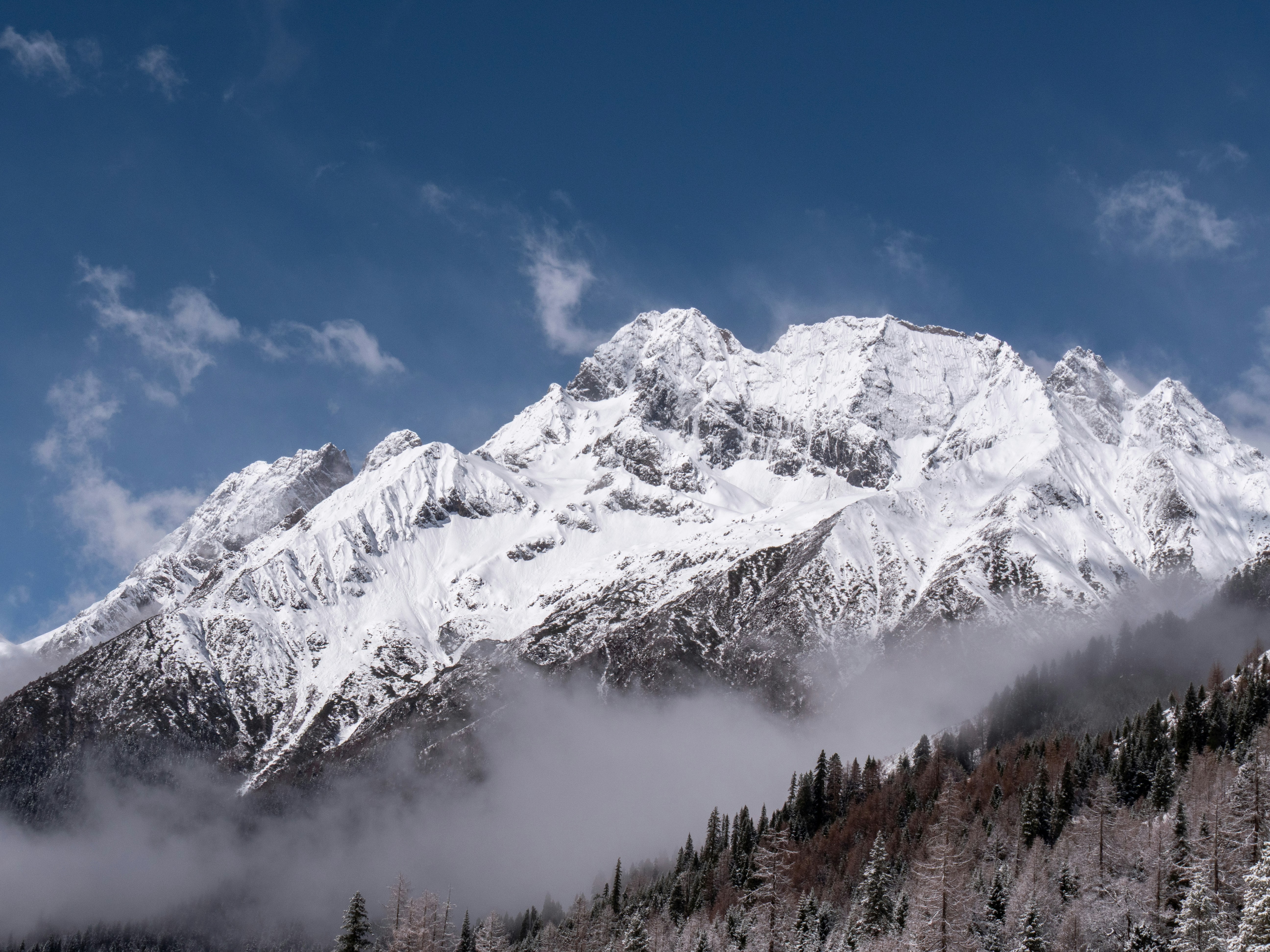 Snowbound Crown: A Peak Pierced by Clear Sky