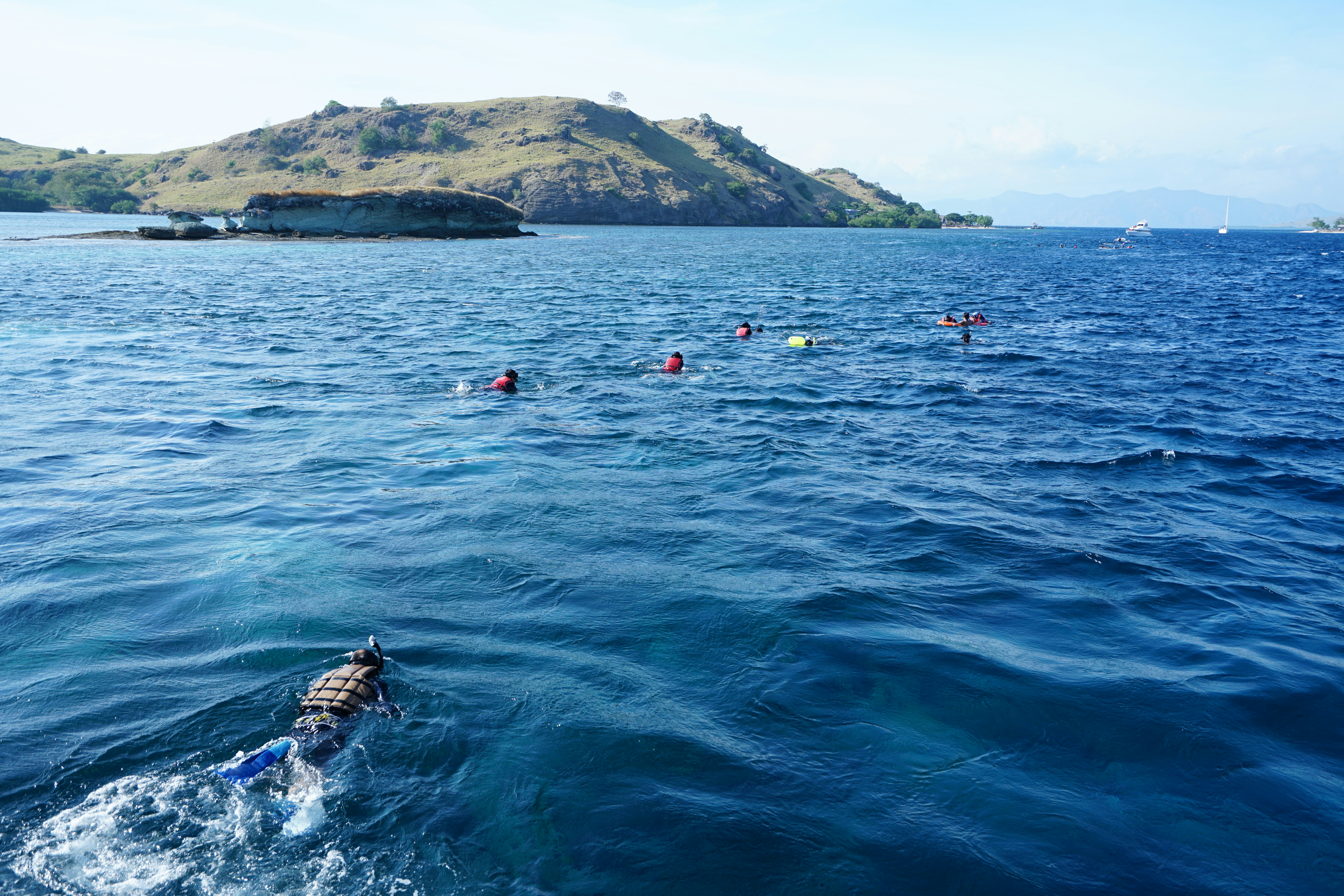 Distant Dunes and Divers: Oceanic Light on a Calm Expedition