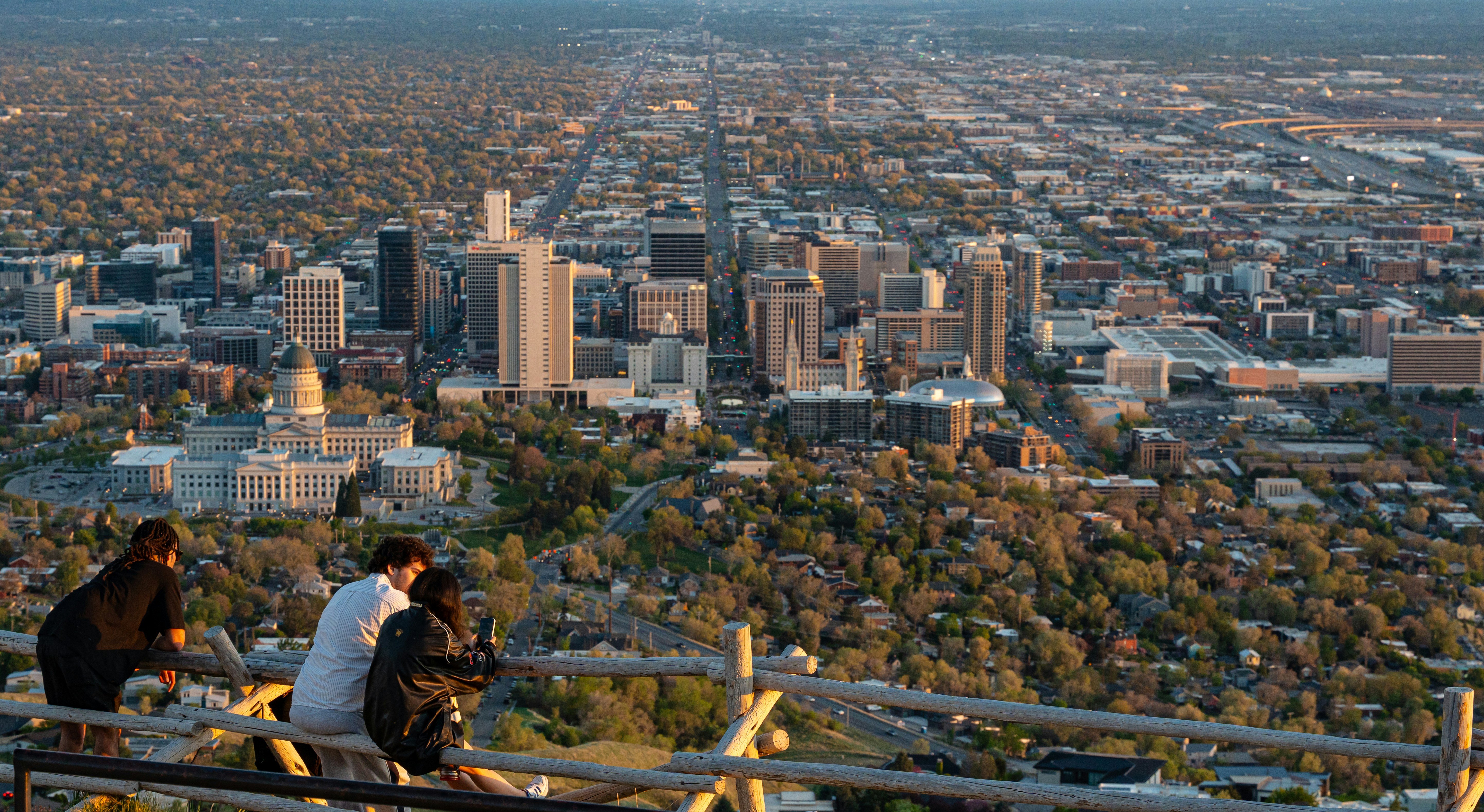Sunset Vista Over the City: Onlookers at the Edge of the Horizon
