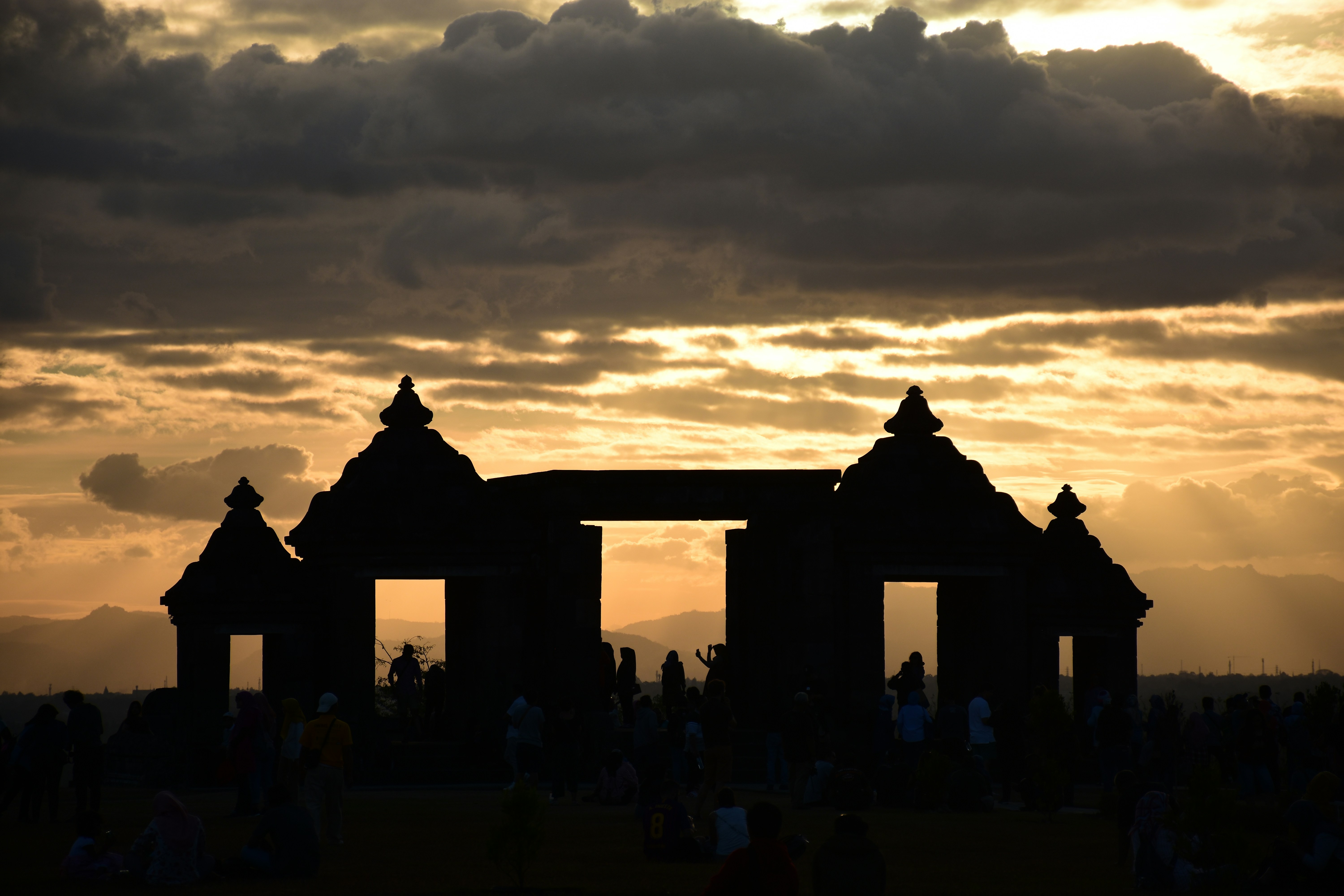 Silhouetted Mandala: Sunset Gate Framed by a Crowd
