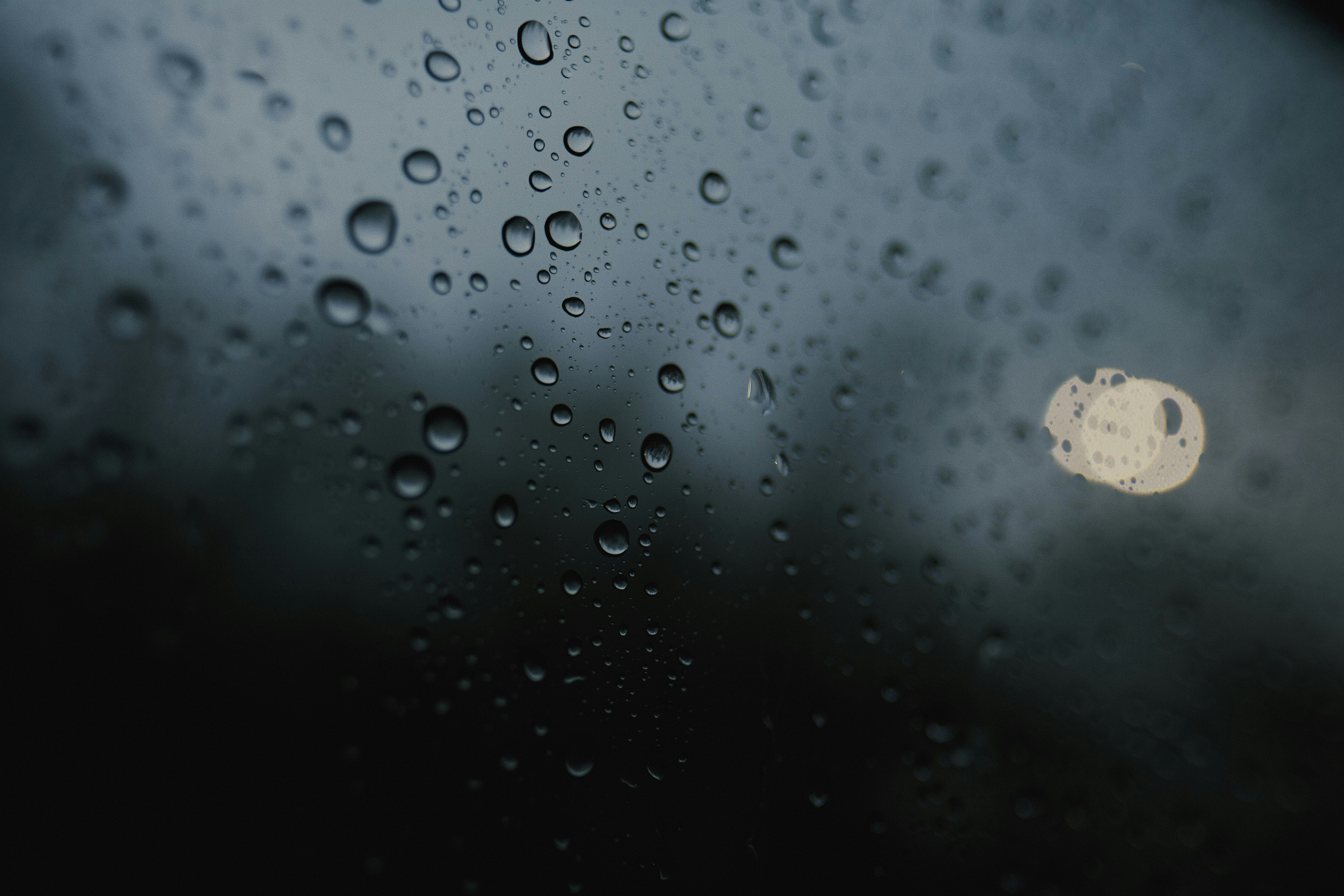 Droplet Mosaic on a Glass Window with Evening Glow