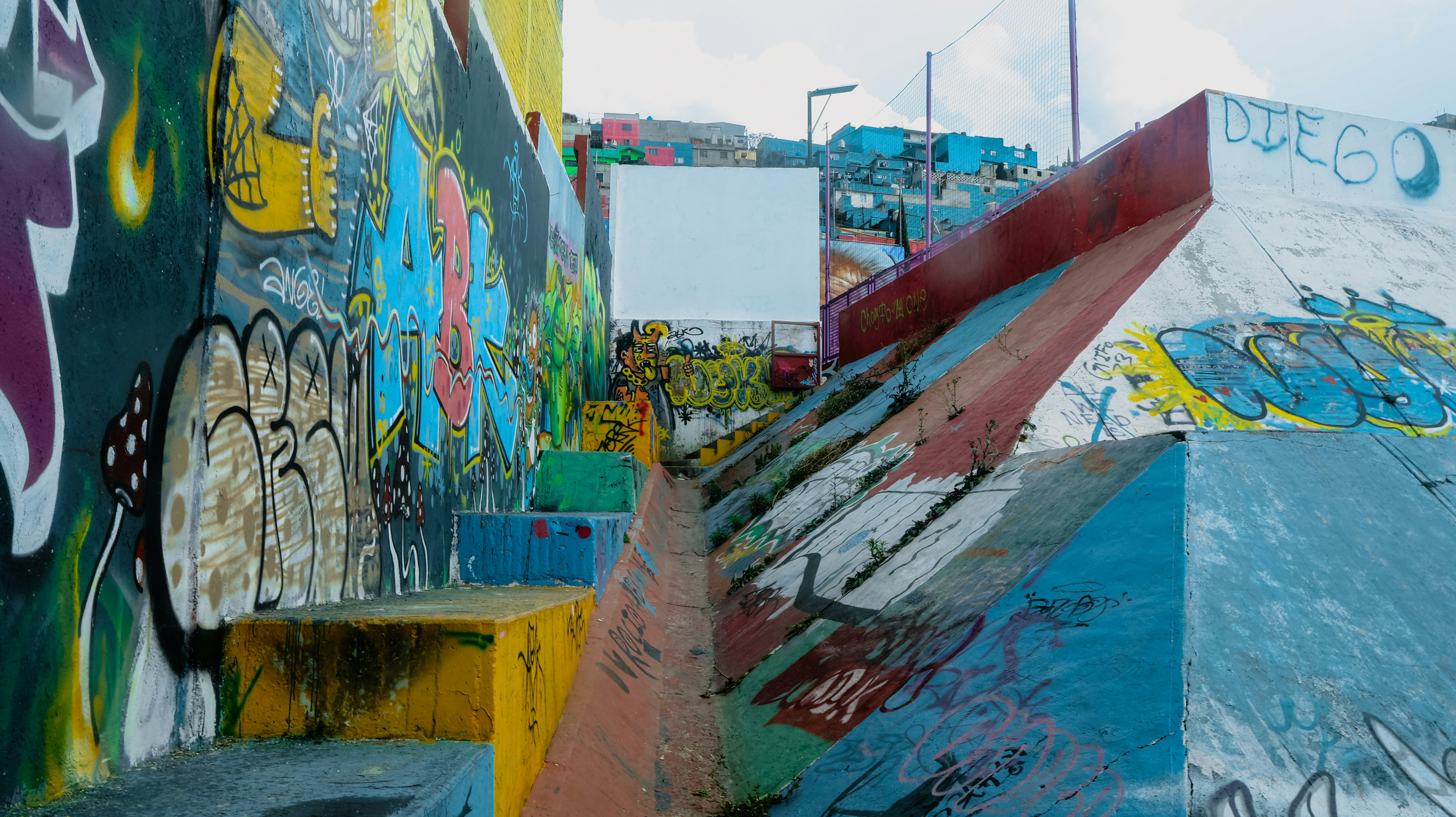 Graffiti Ramp Ascent at a Color-Splashed Skate Park