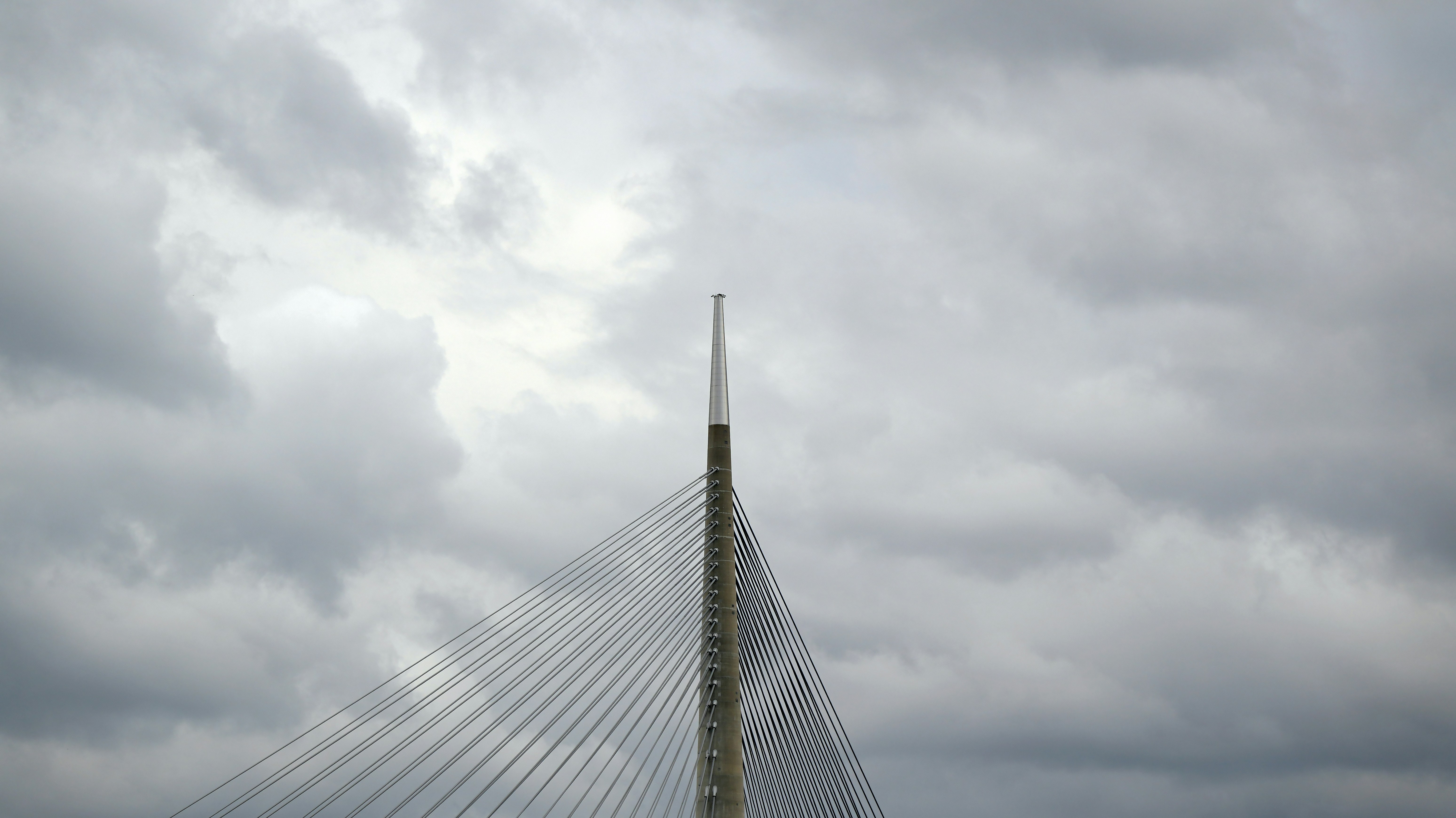 Cables Converge: A Lone Spire Against Brooding Skies