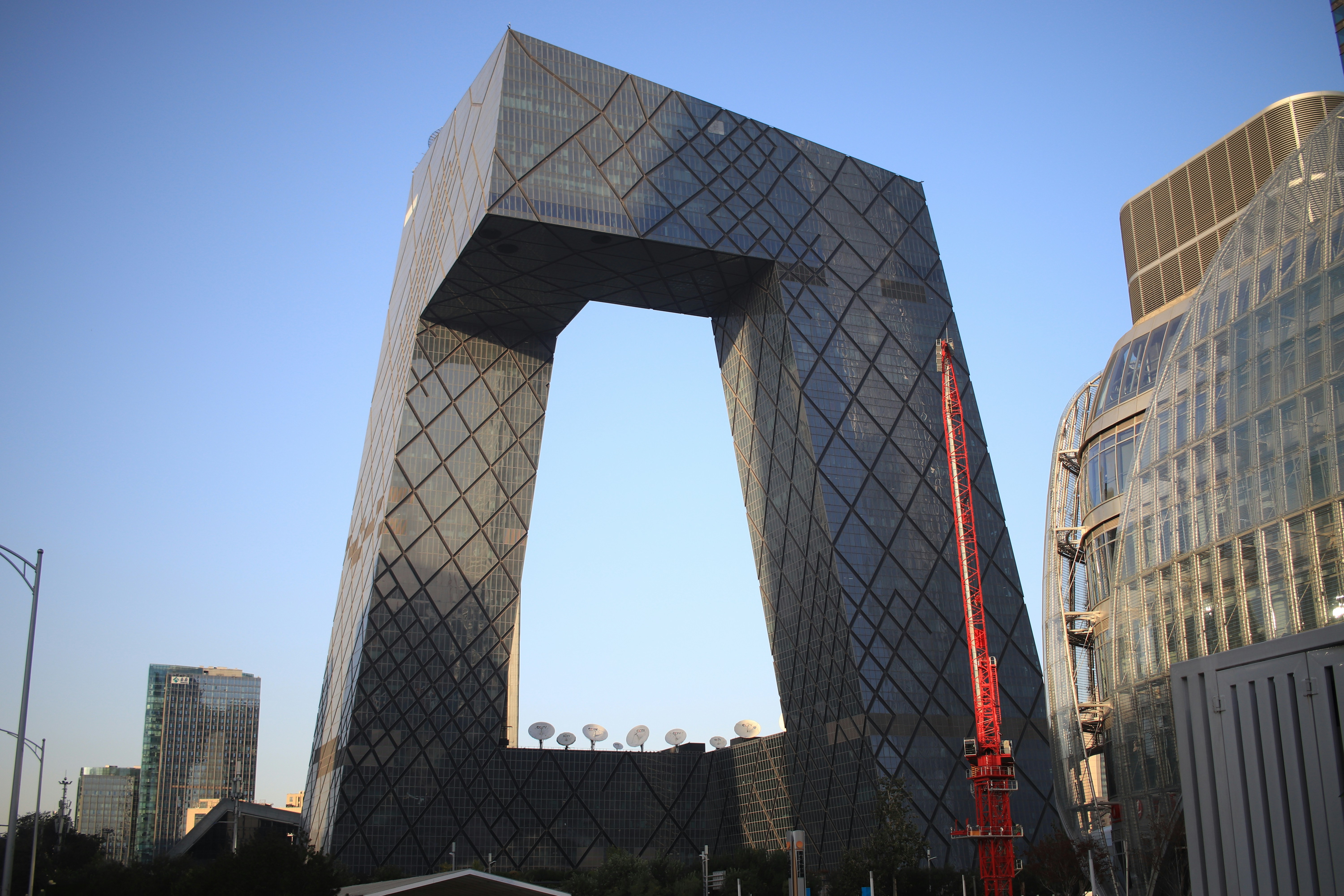 Gateway of steel: a modern arch framed by glass towers