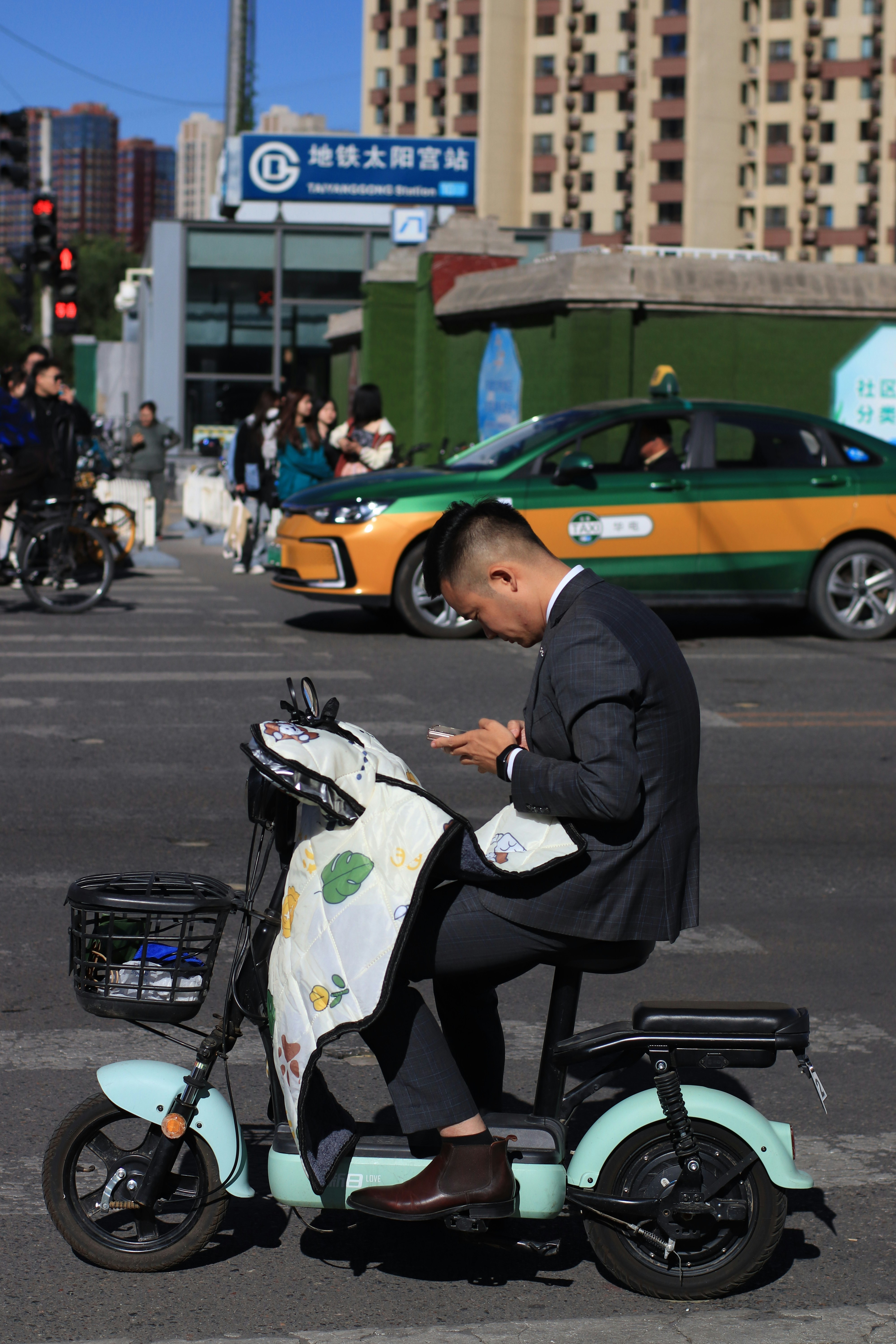 A Suit-and-Scooter Moment in a Busy City Crosswalk