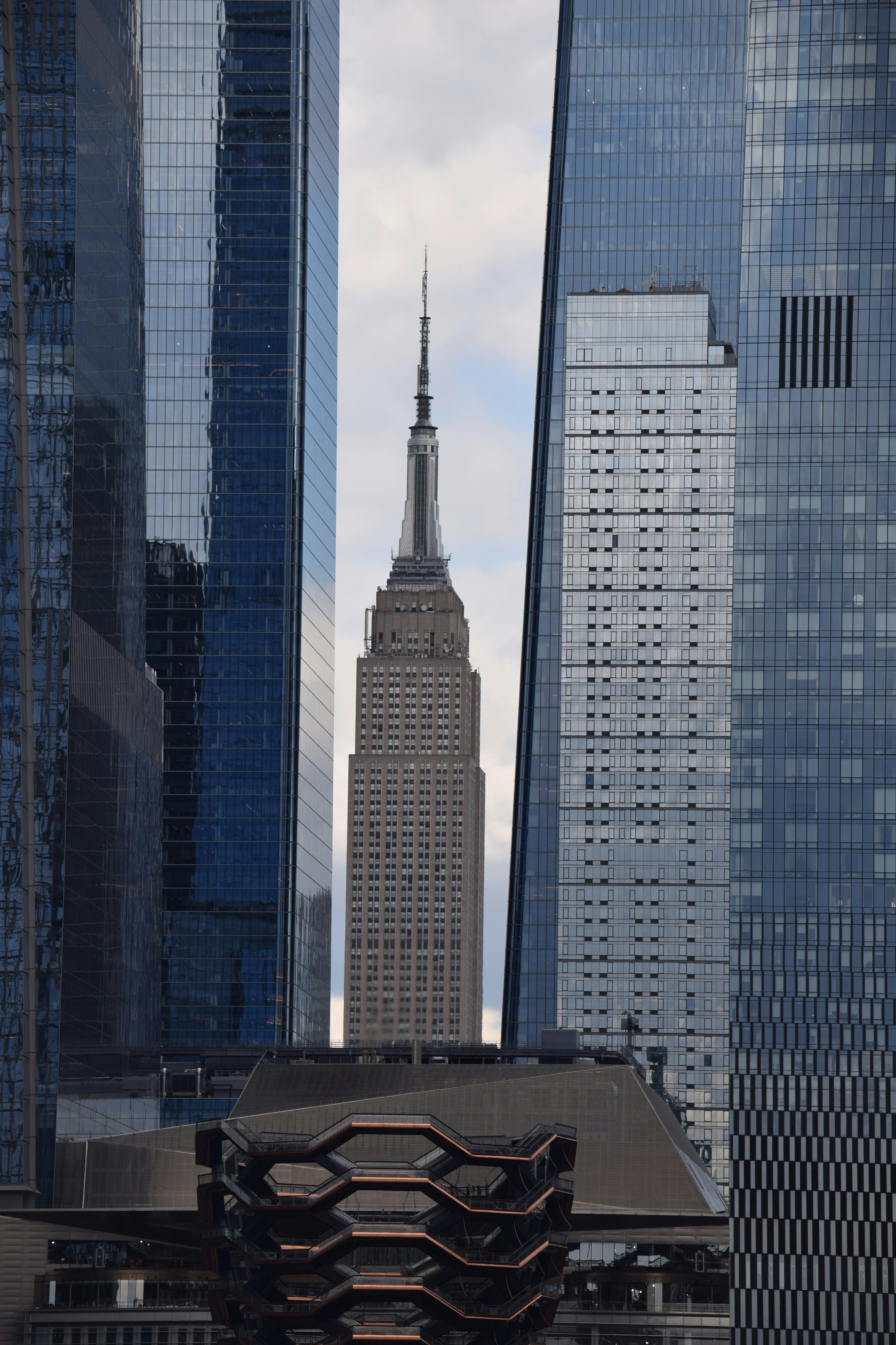 Midtown Needle: Empire State Between Glass Giants